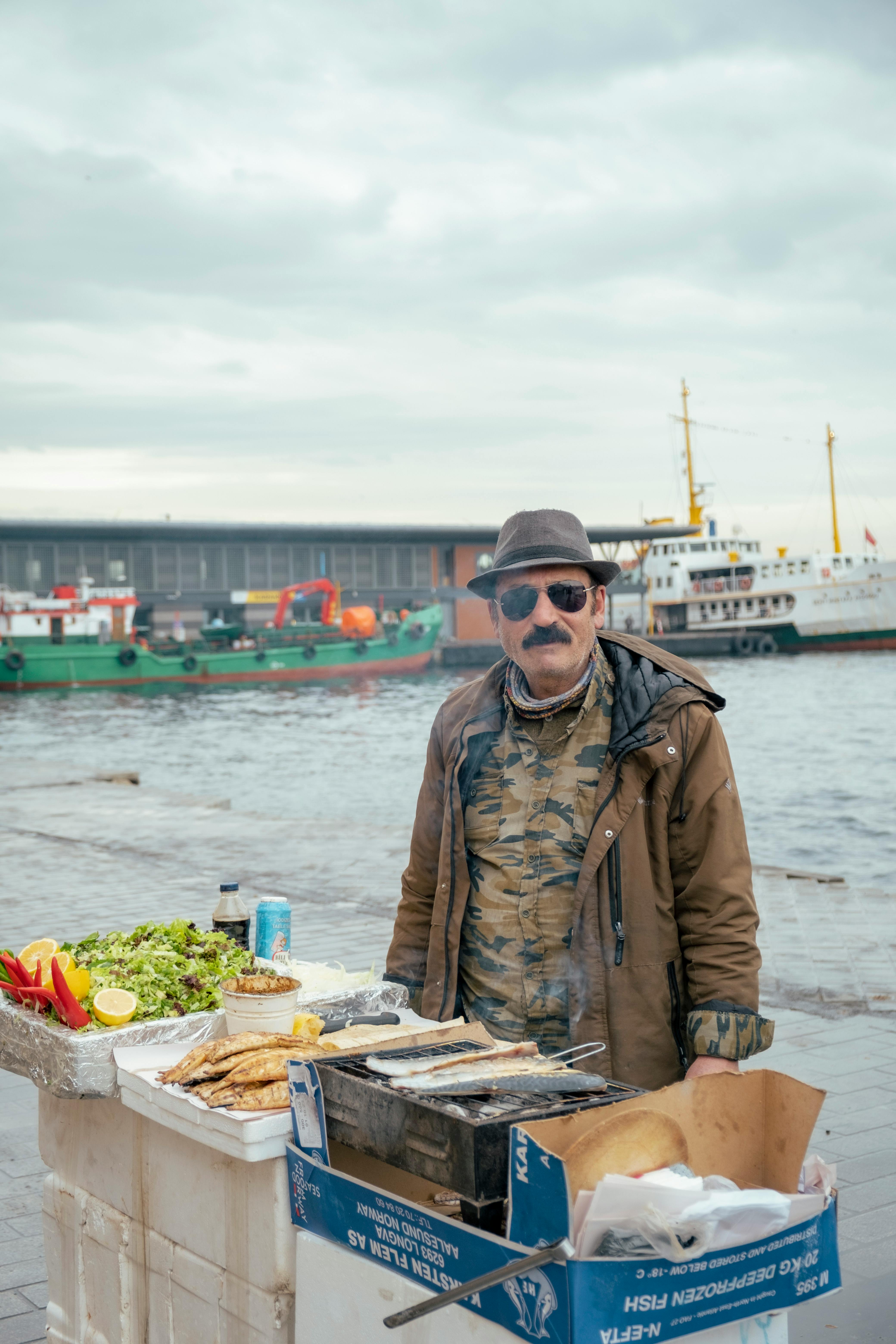 Man Selling Fish in Sea Harbor · Free Stock Photo