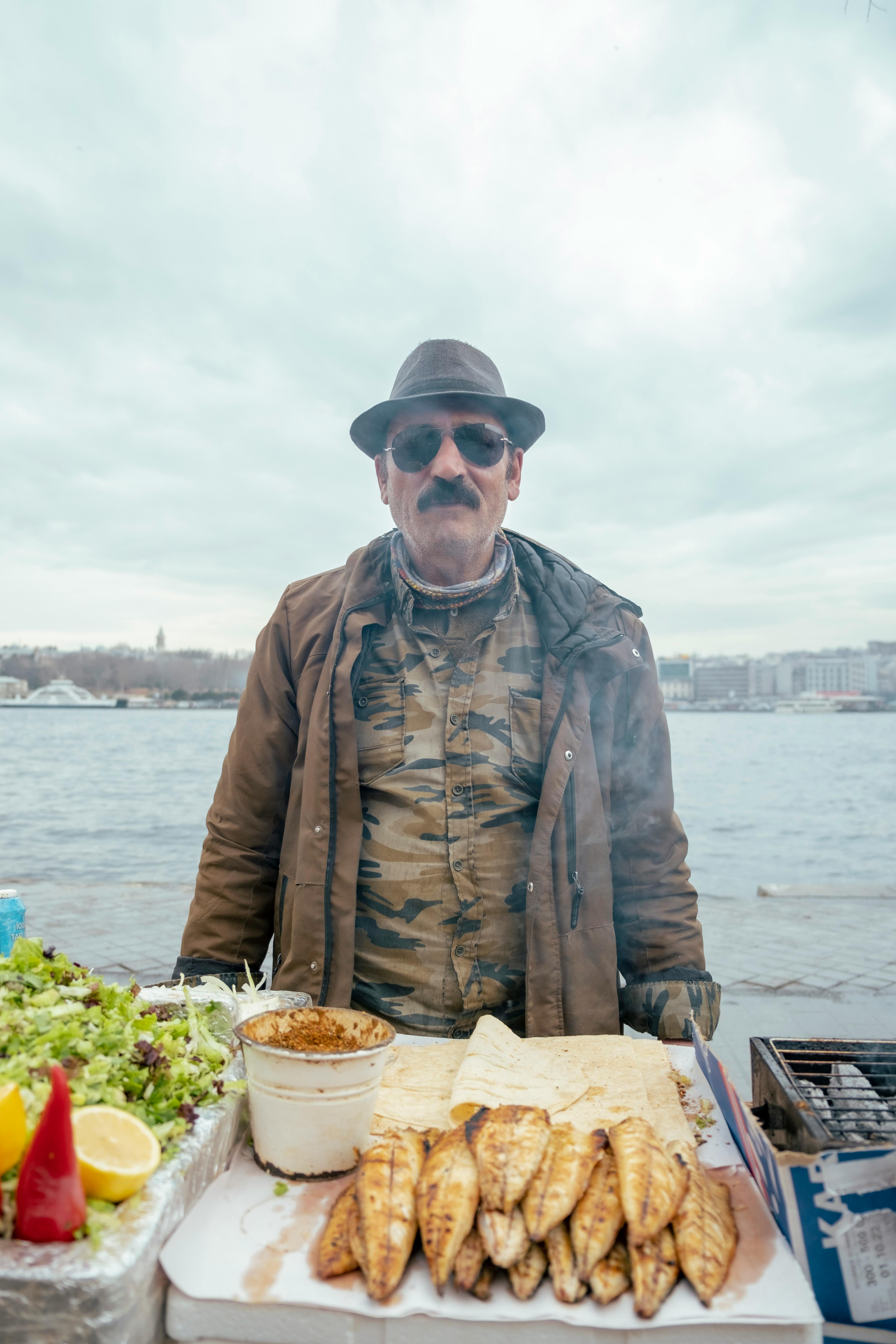 Man on Food Stand with Fish · Free Stock Photo