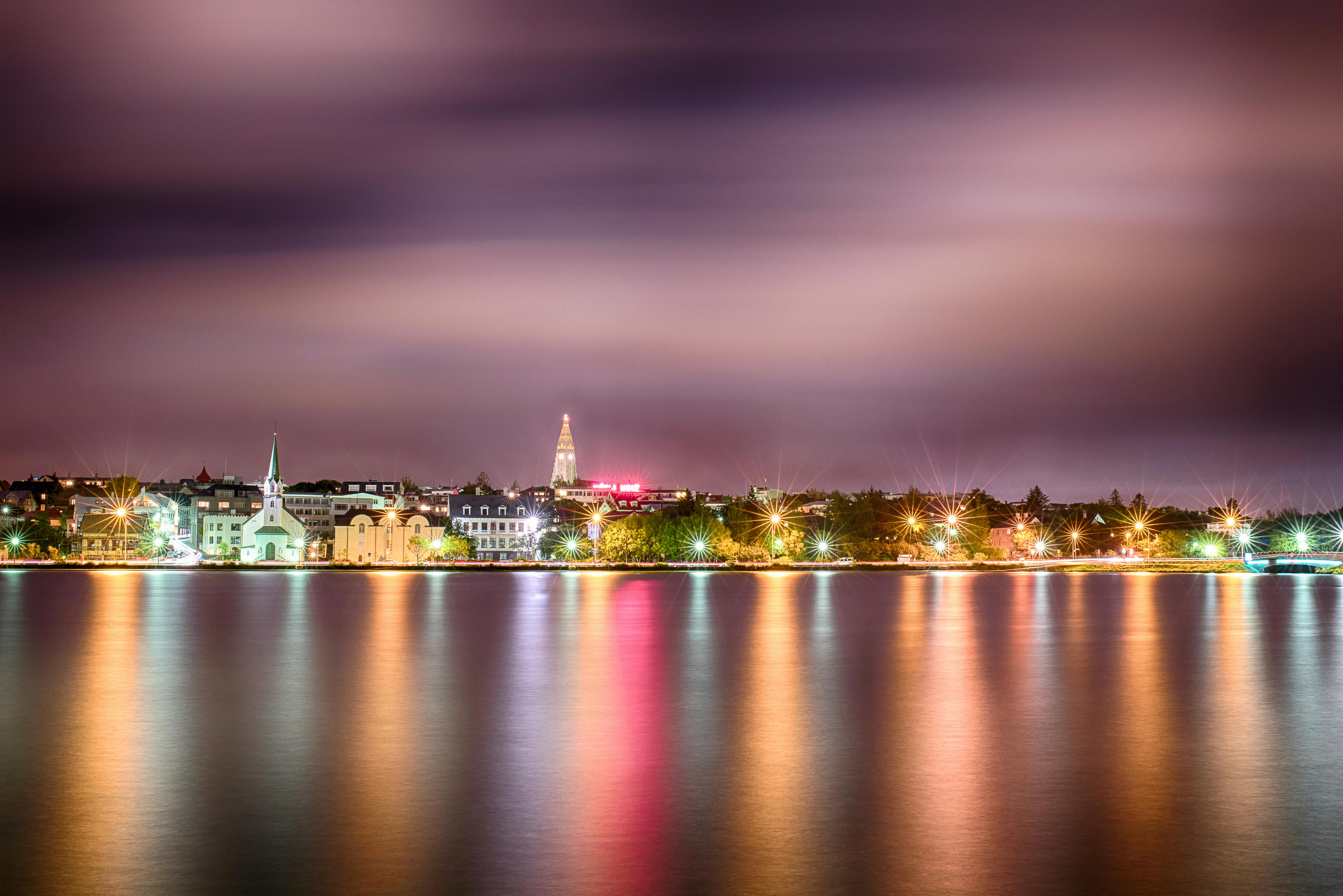 Illuminated Town by Lake at Night · Free Stock Photo