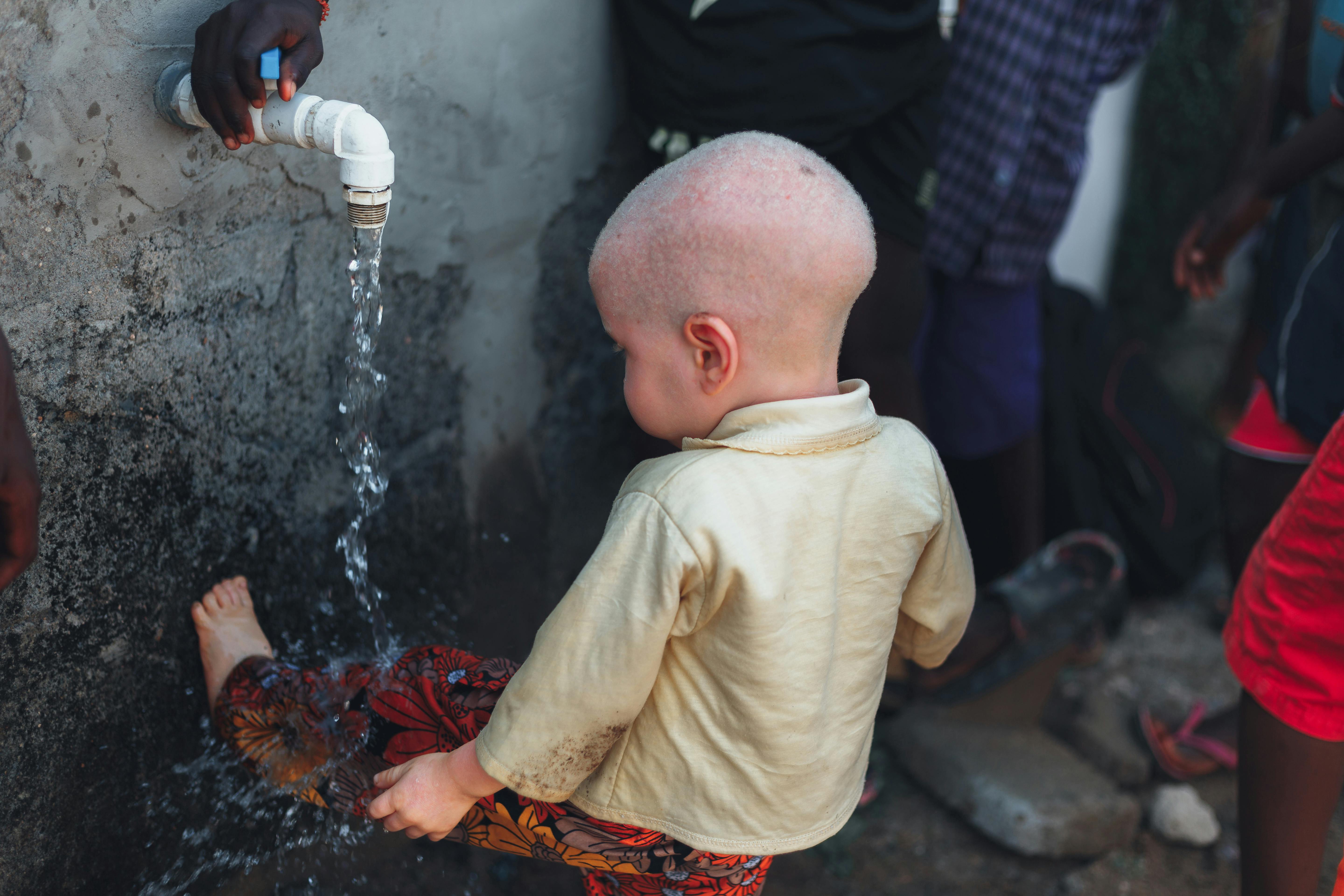 Back View of Boy Washing Leg · Free Stock Photo