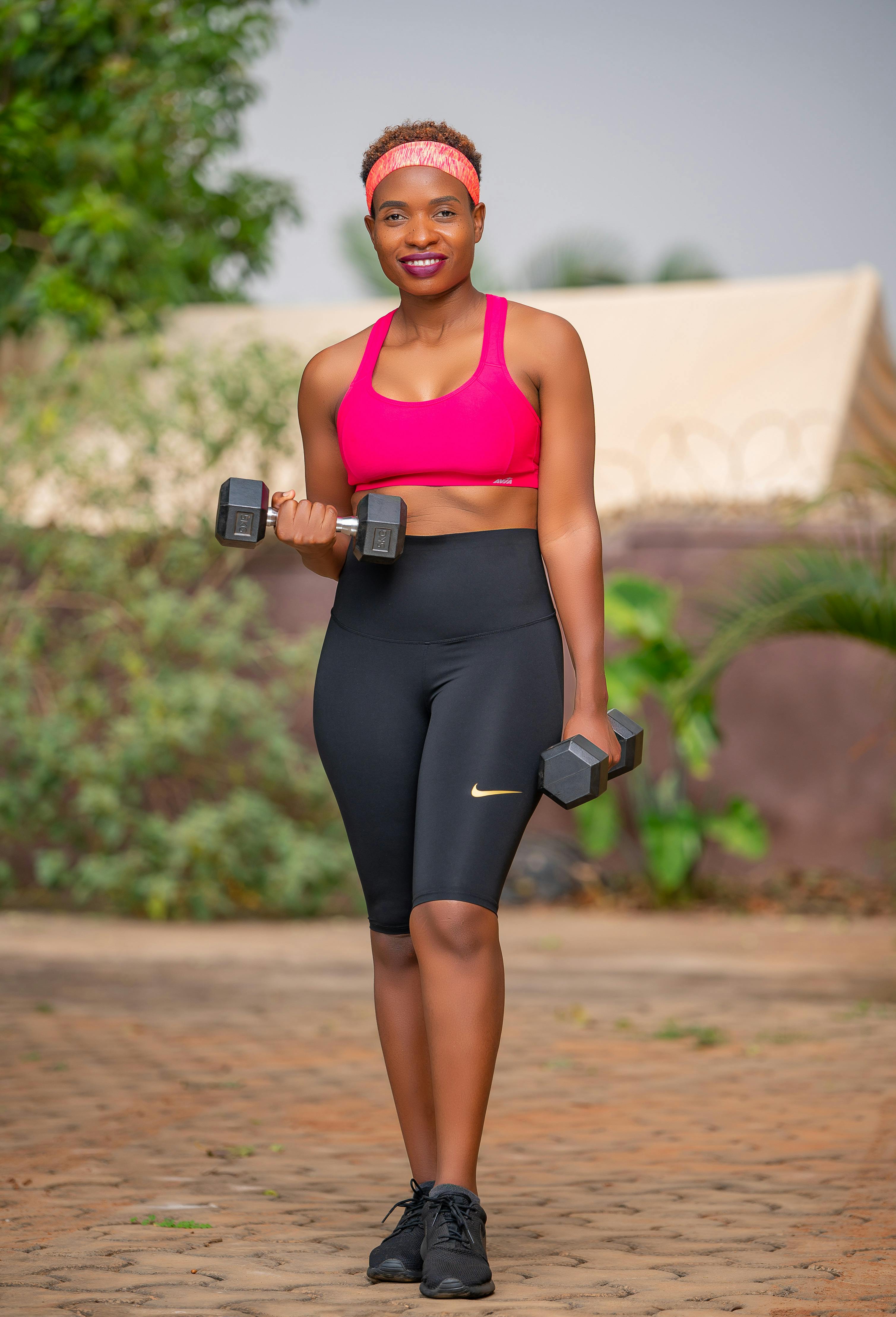 Women's Assorted Sports Bras Raising Their Pink Dumbbells · Free Stock ...