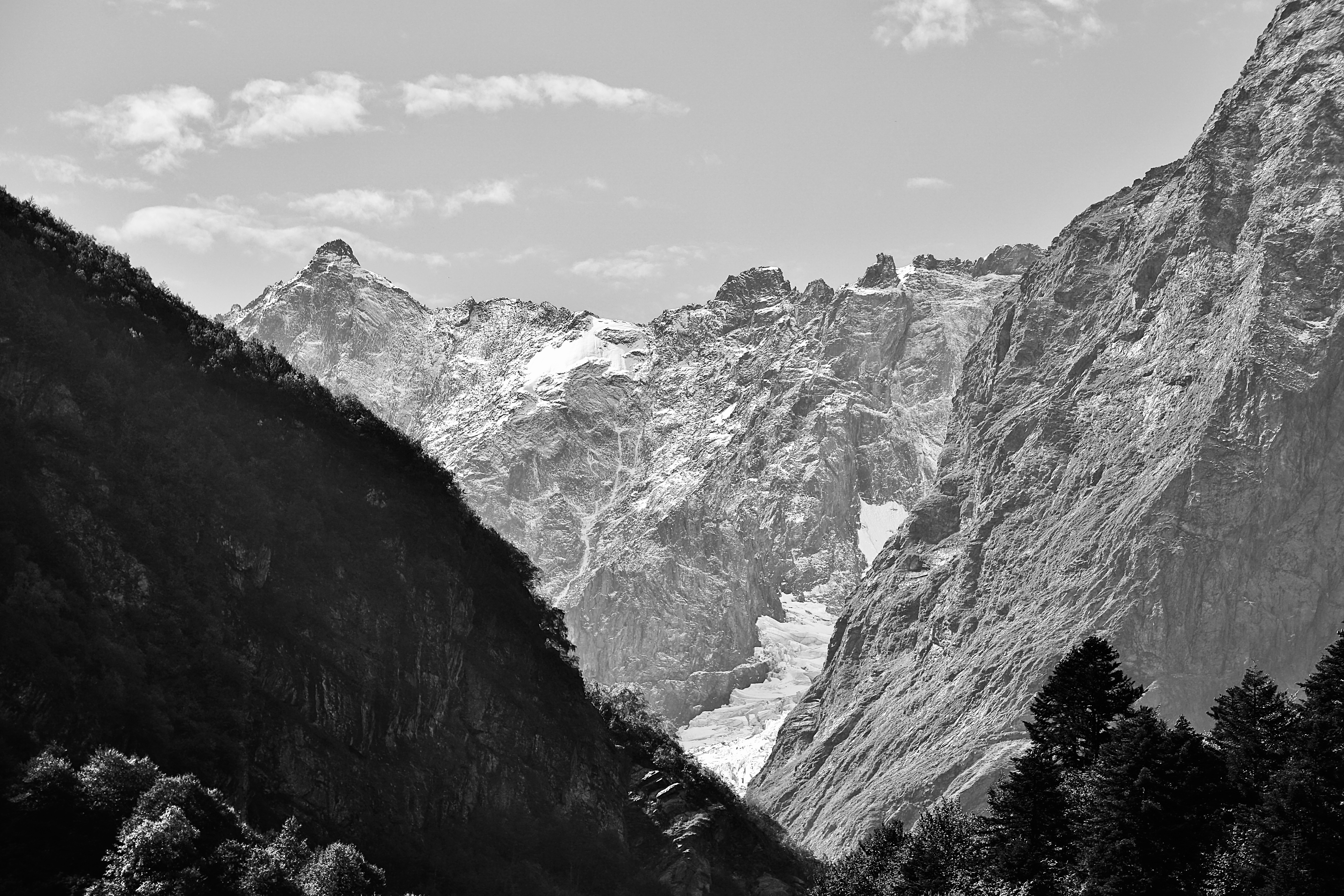 Grayscale Photo of Rocky Mountains with Snow · Free Stock Photo