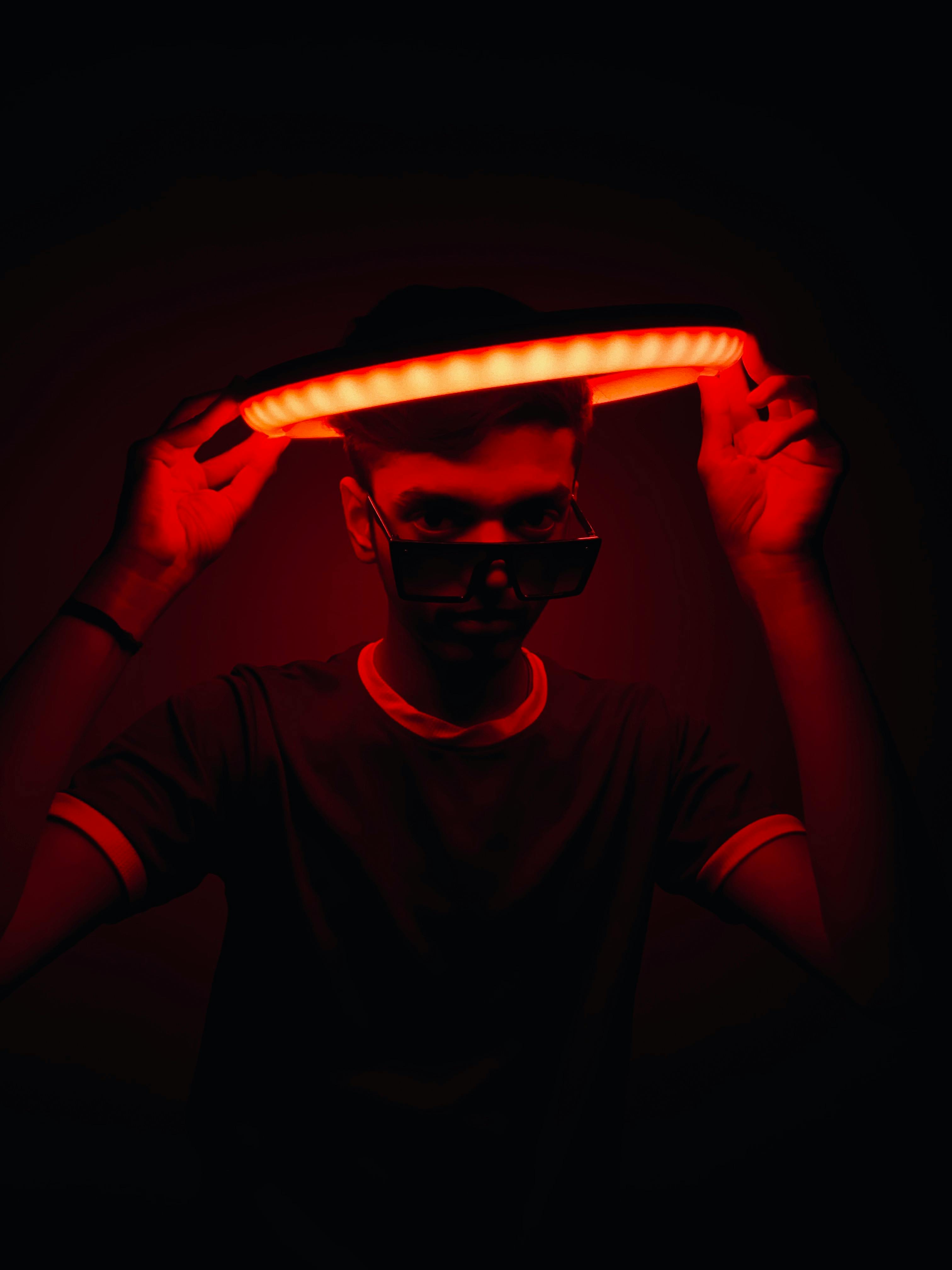 Man Holding Lamp above Head · Free Stock Photo