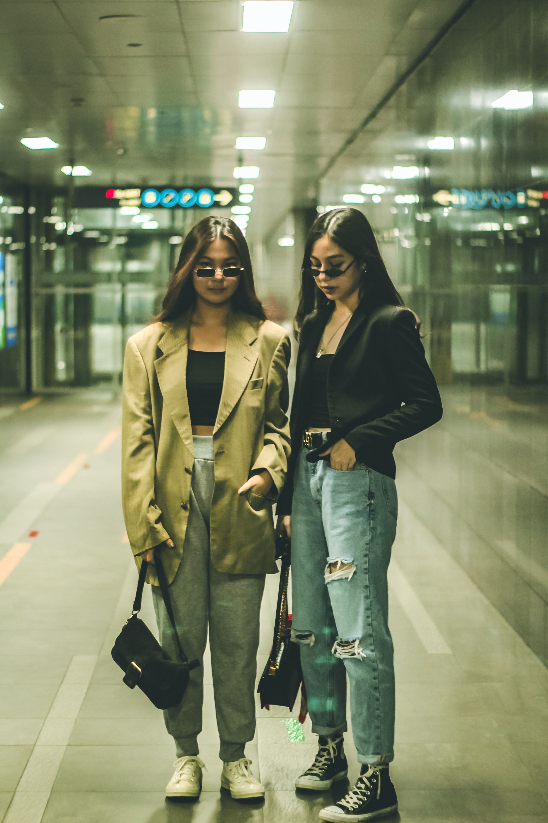 Young Women in Fashionable Outfits Standing at a Subway Station · Free ...