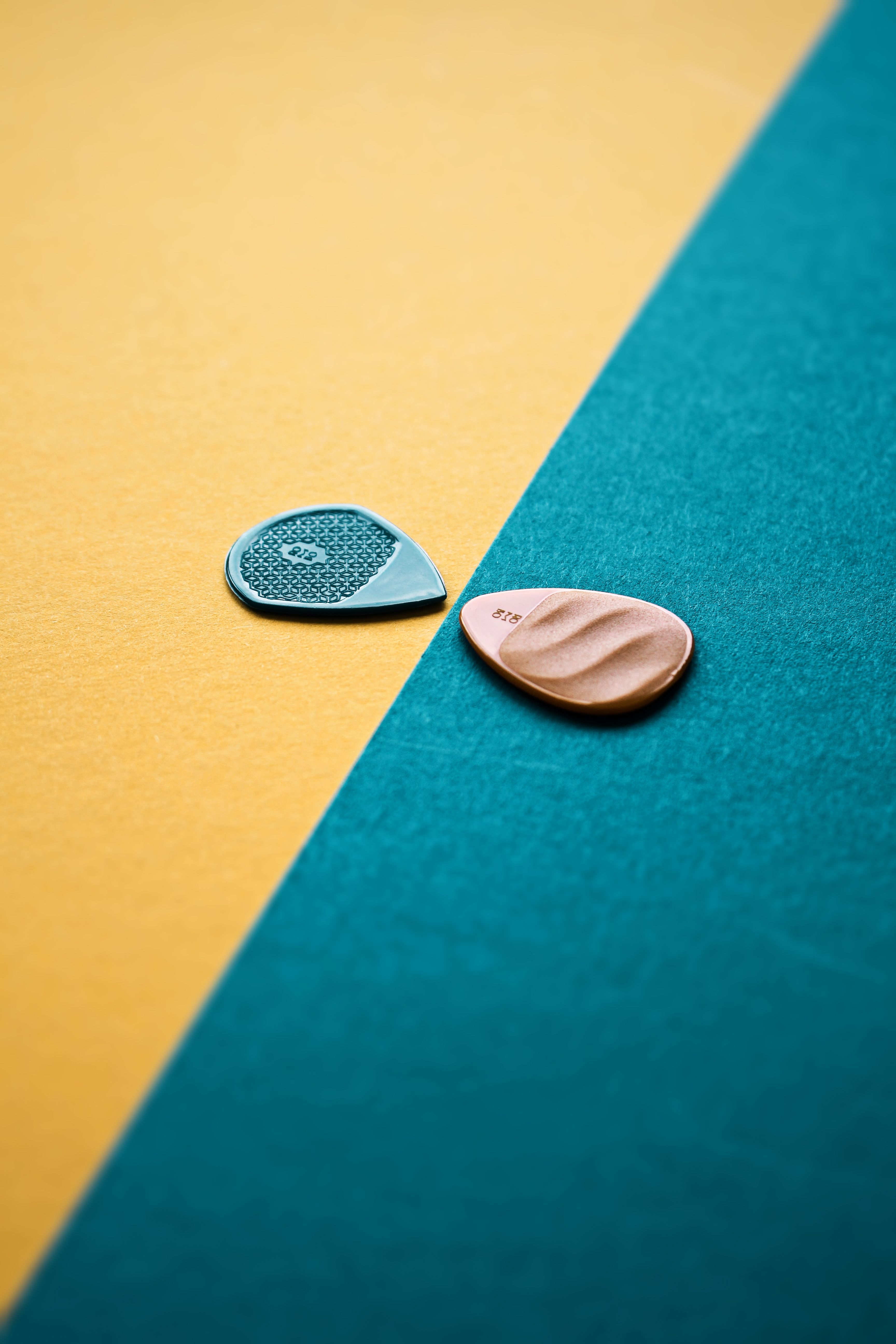 Close-up of Guitar Picks Lying on Two Colored Background · Free Stock Photo