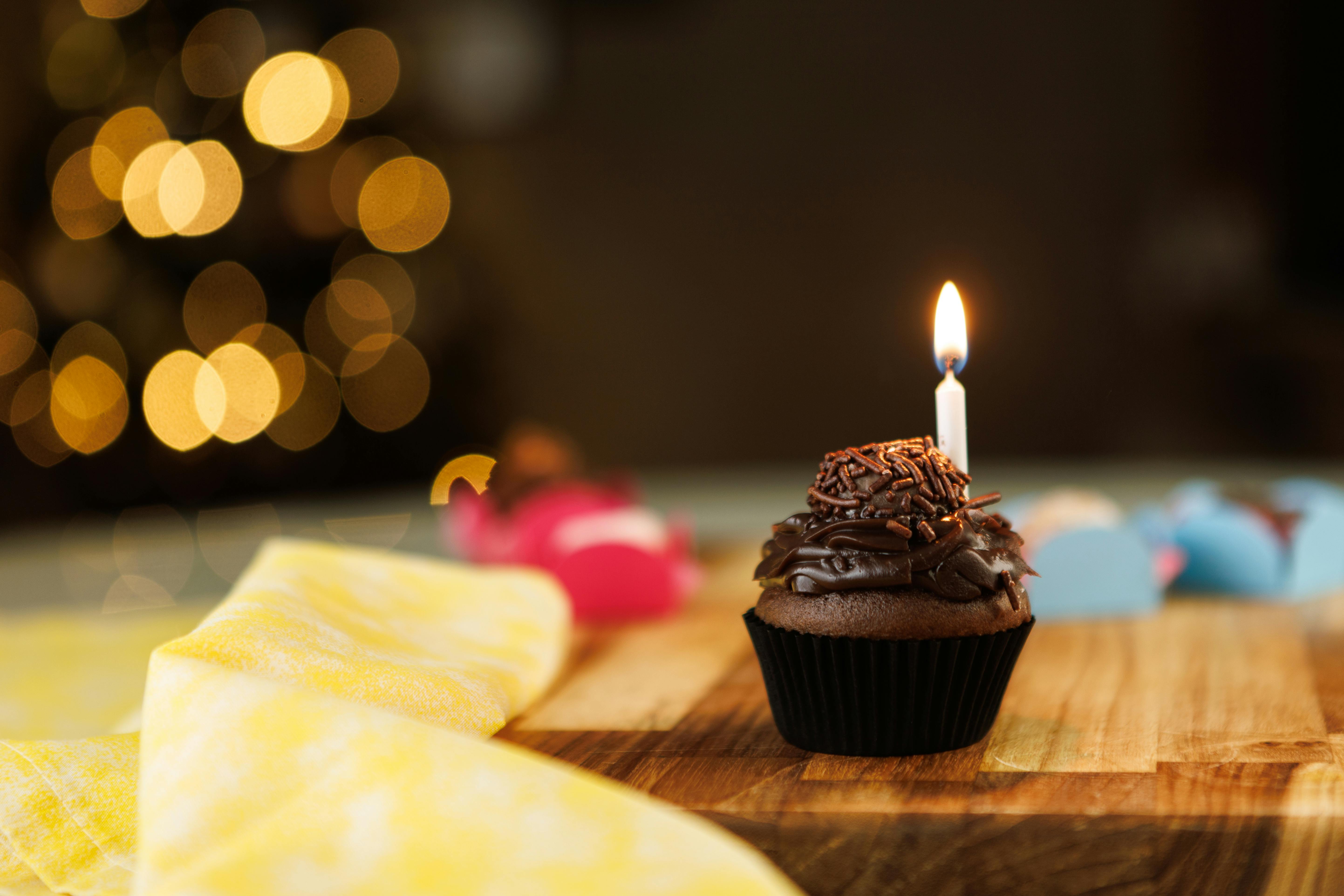 Wax Candle behind Chocolate Cupcake · Free Stock Photo