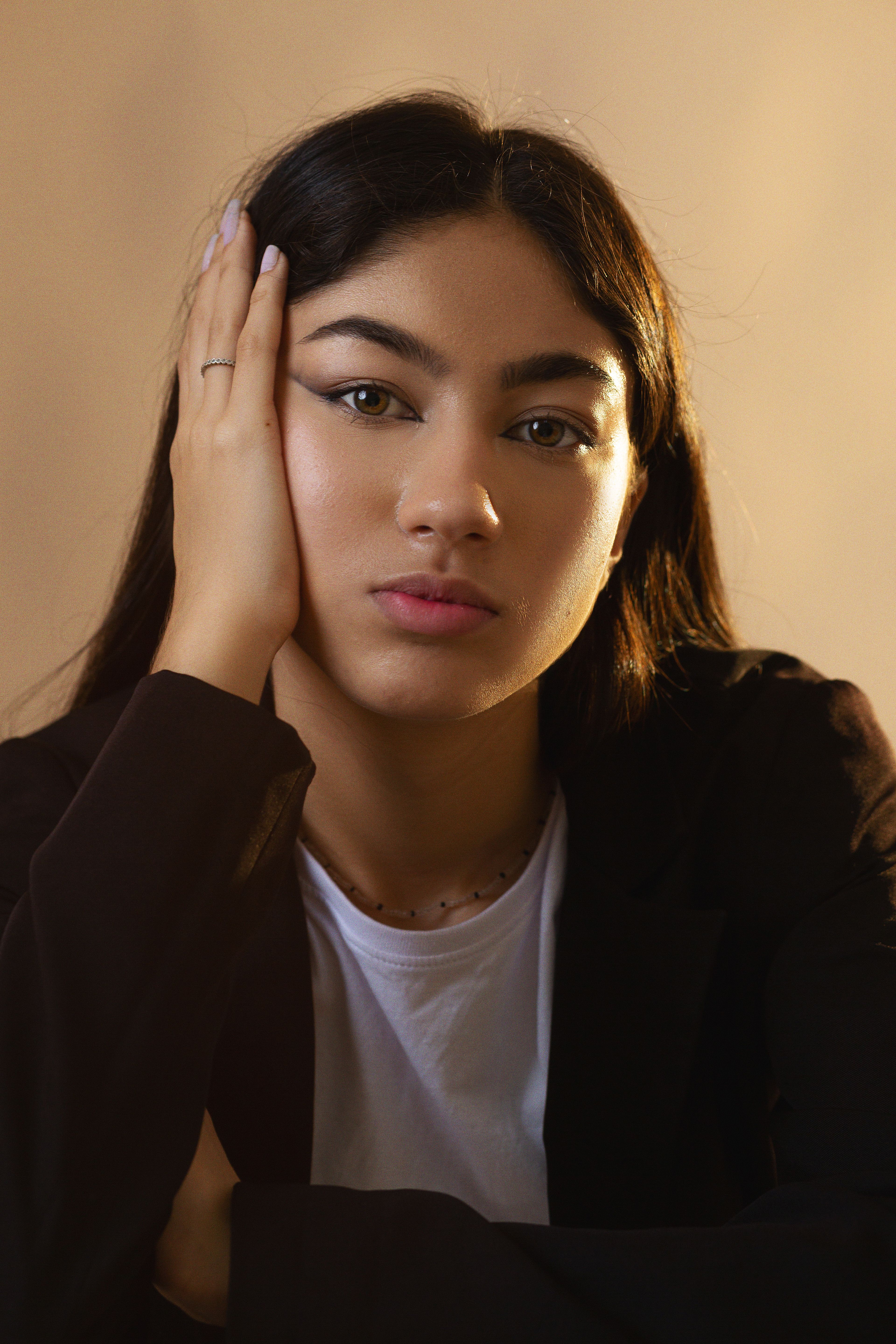 Portrait of a Girl with Her Hand on Her Cheek · Free Stock Photo
