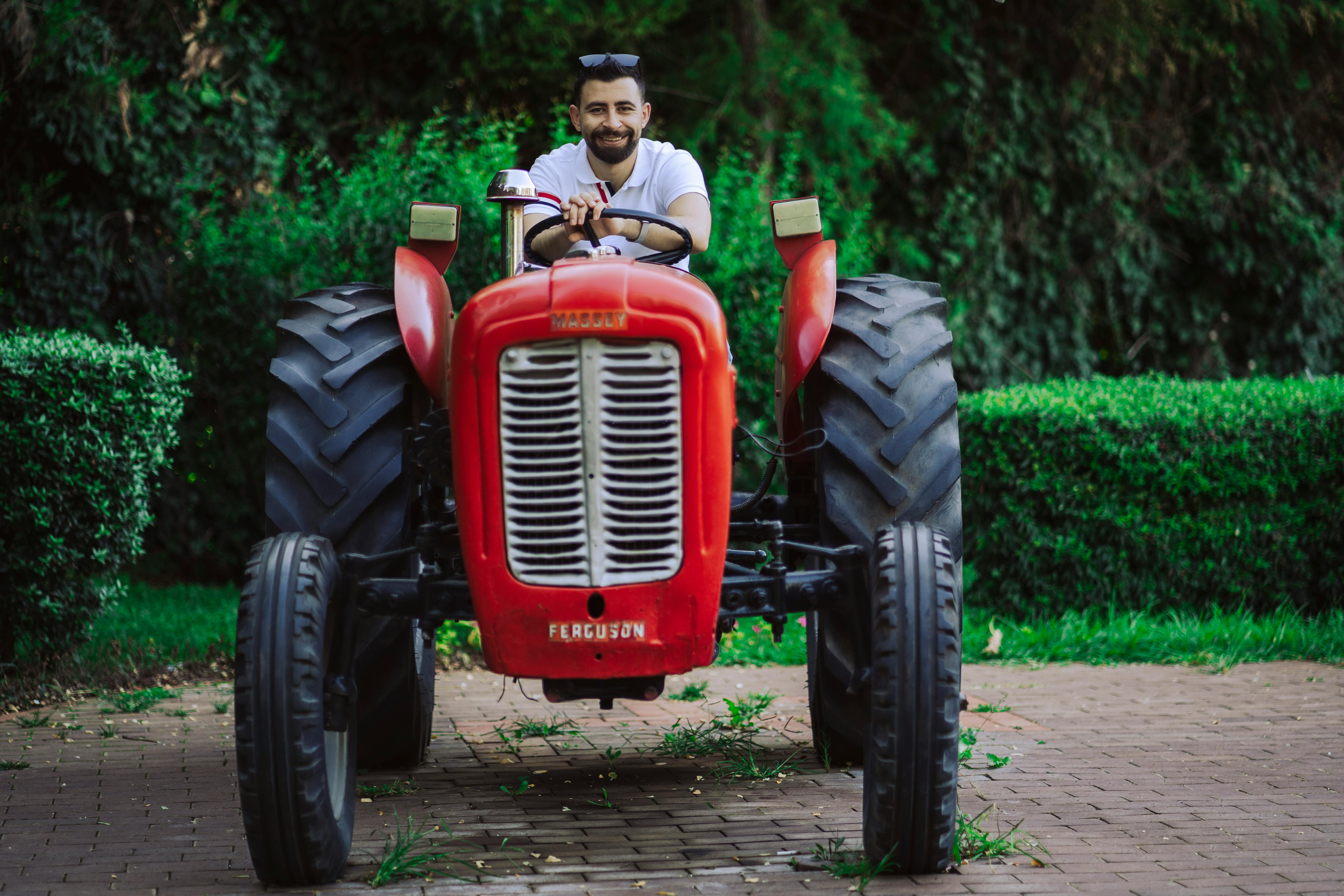 Man Driving a Red Tractor · Free Stock Photo