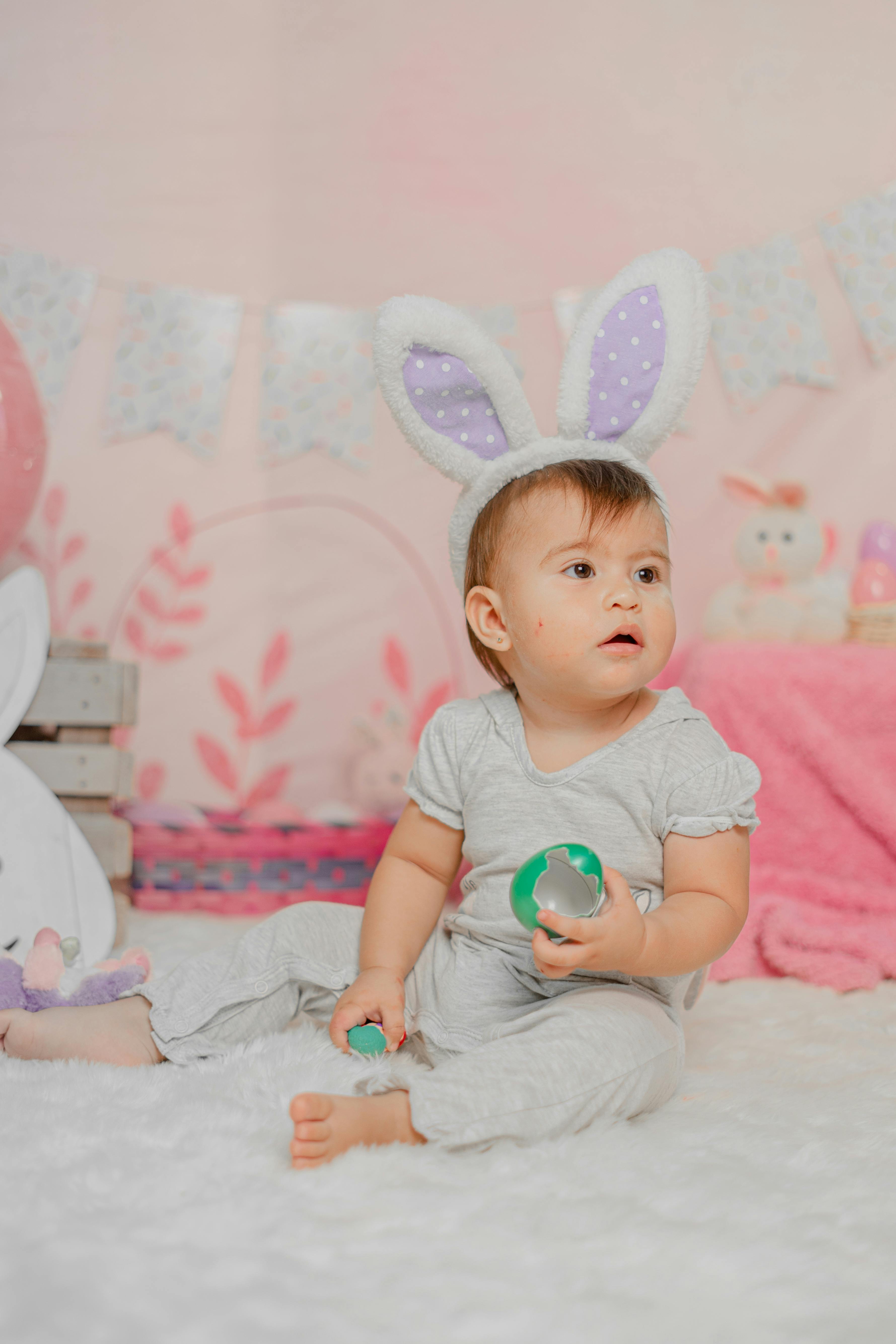 Baby Girl Wearing Bunny Ears Headband While Holding an Egg · Free Stock ...