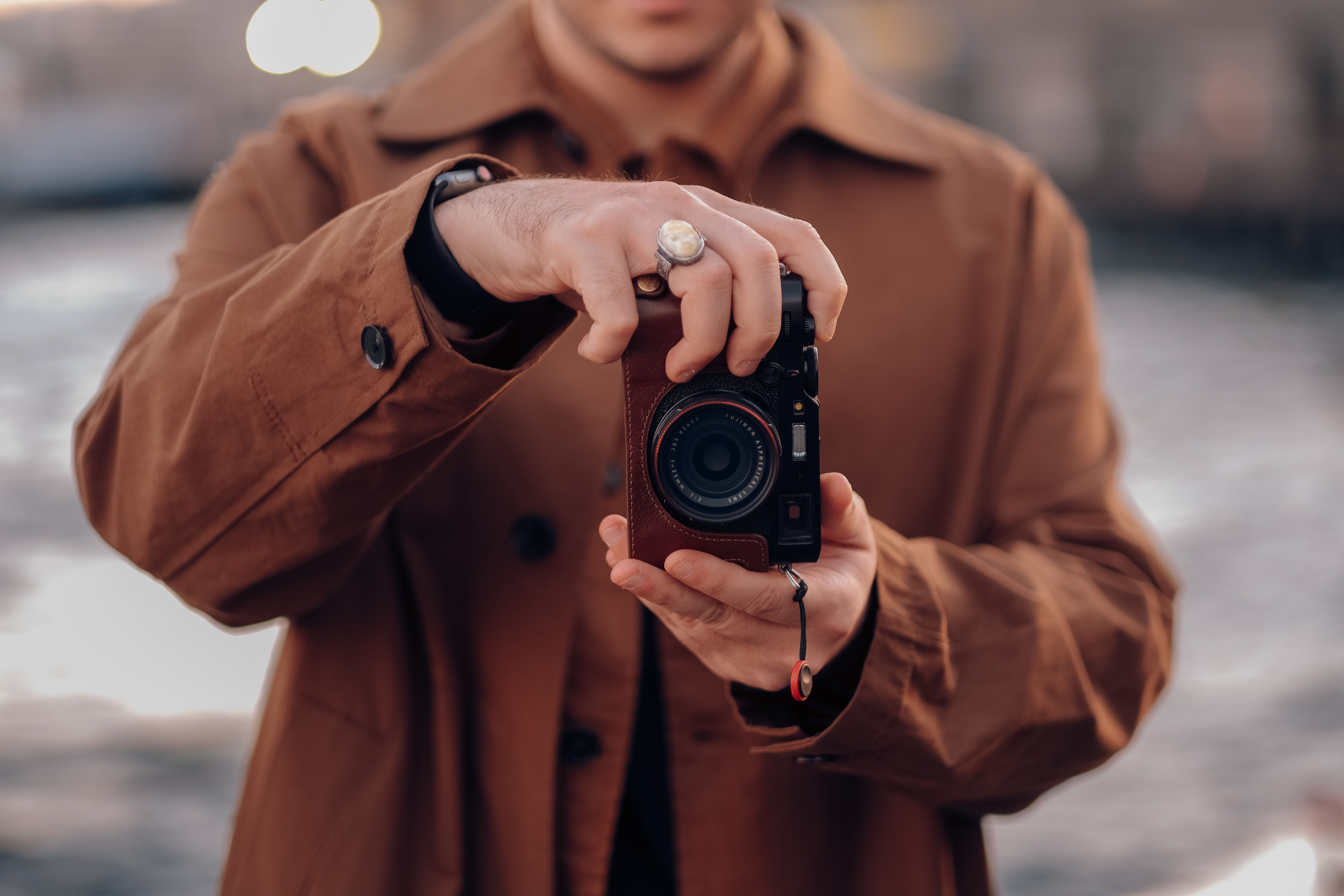 Person Wearing Coat Holding a Camera · Free Stock Photo