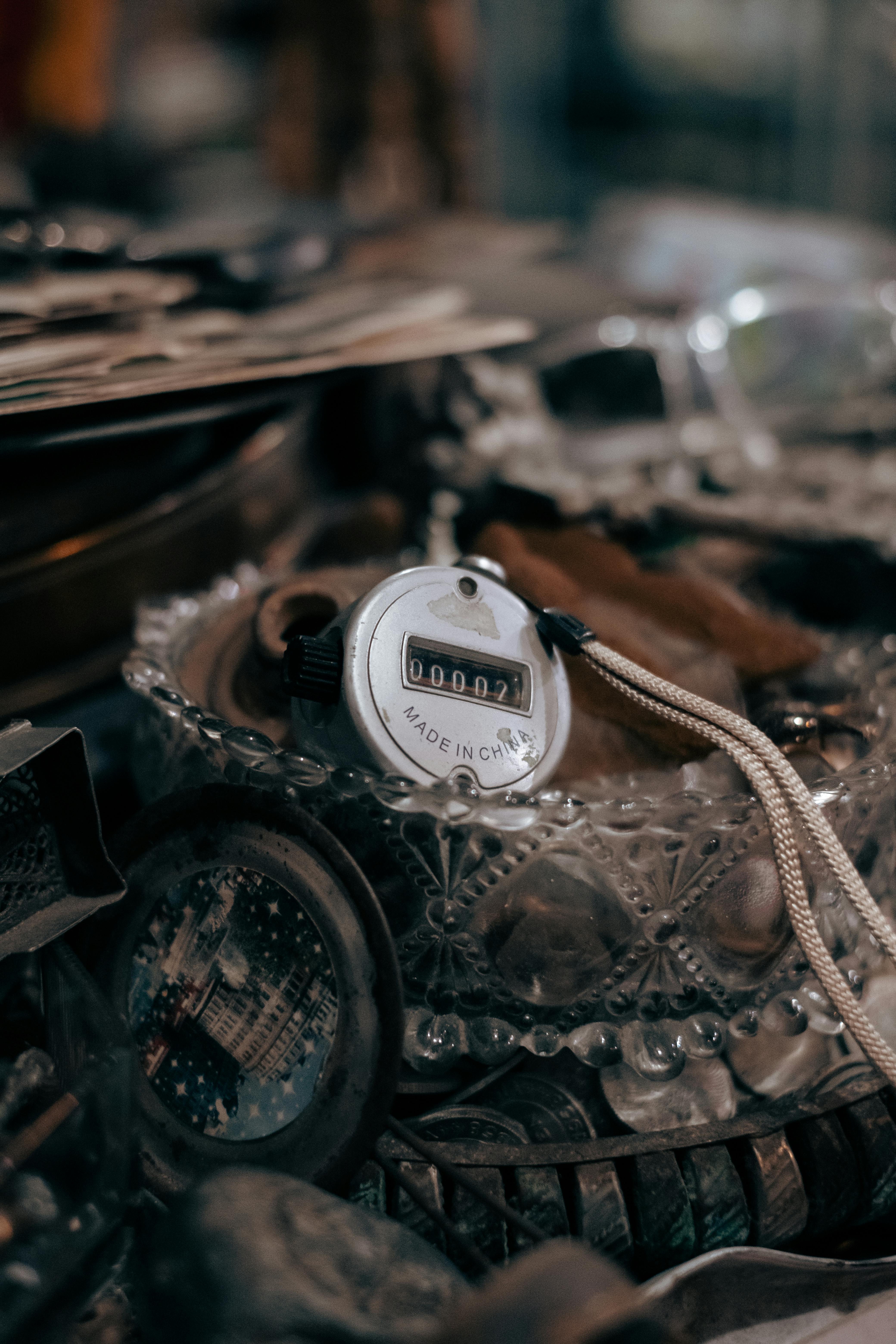 Mechanical Tally Counter on a Pile of Old Trinkets · Free Stock Photo