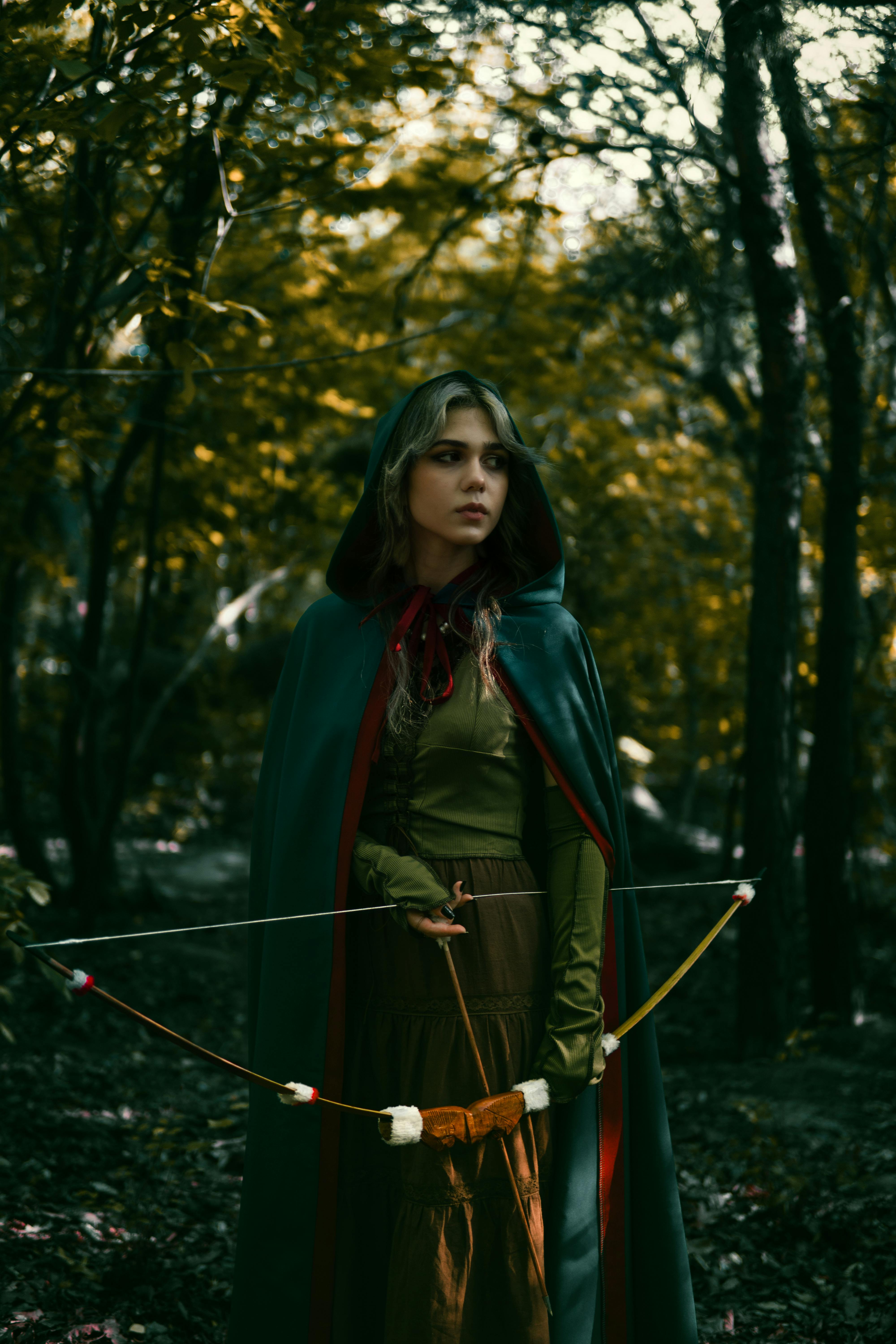 Woman Holding a Bow and Arrow · Free Stock Photo