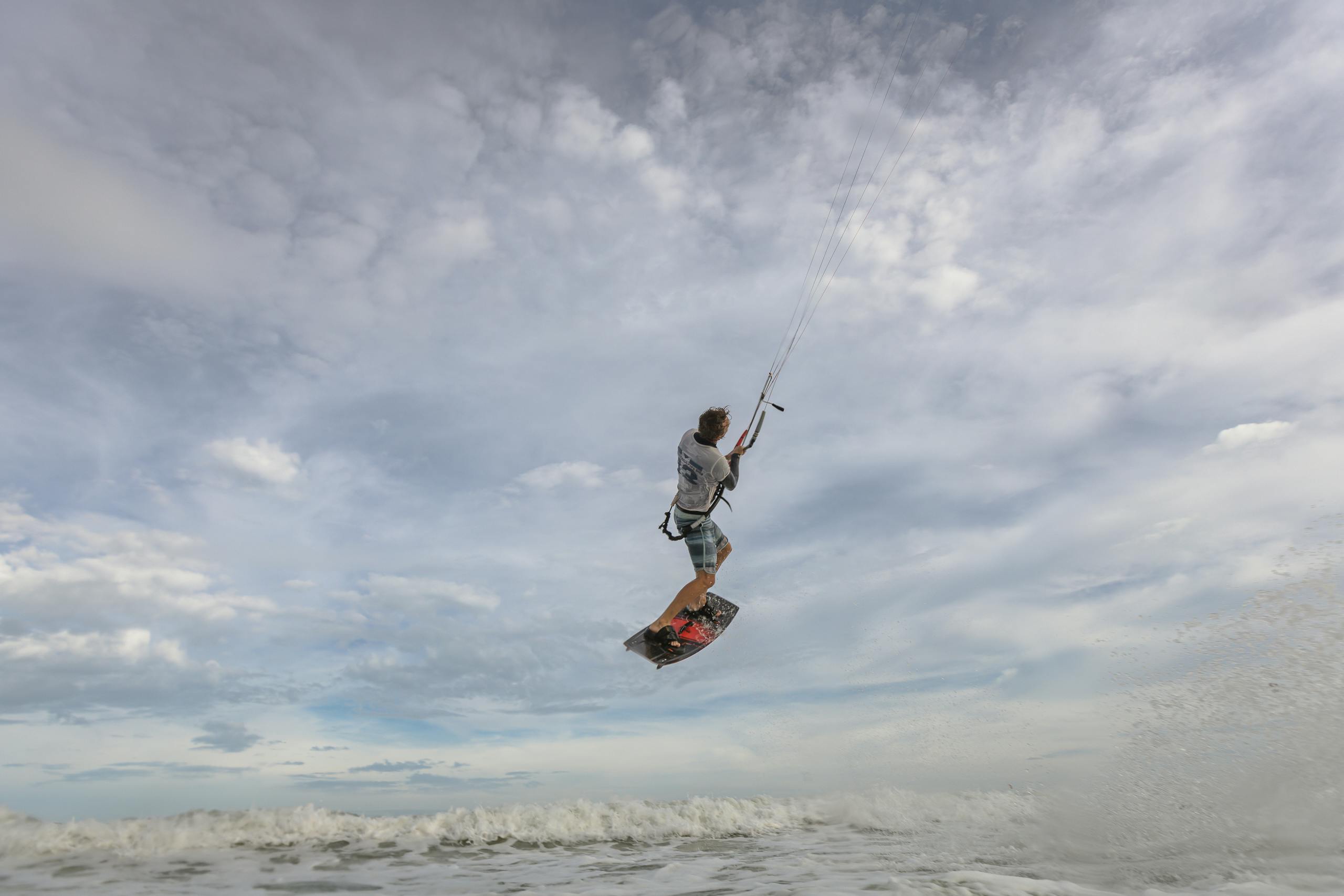 Back View of a Man Kitesurfing in Sea · Free Stock Photo