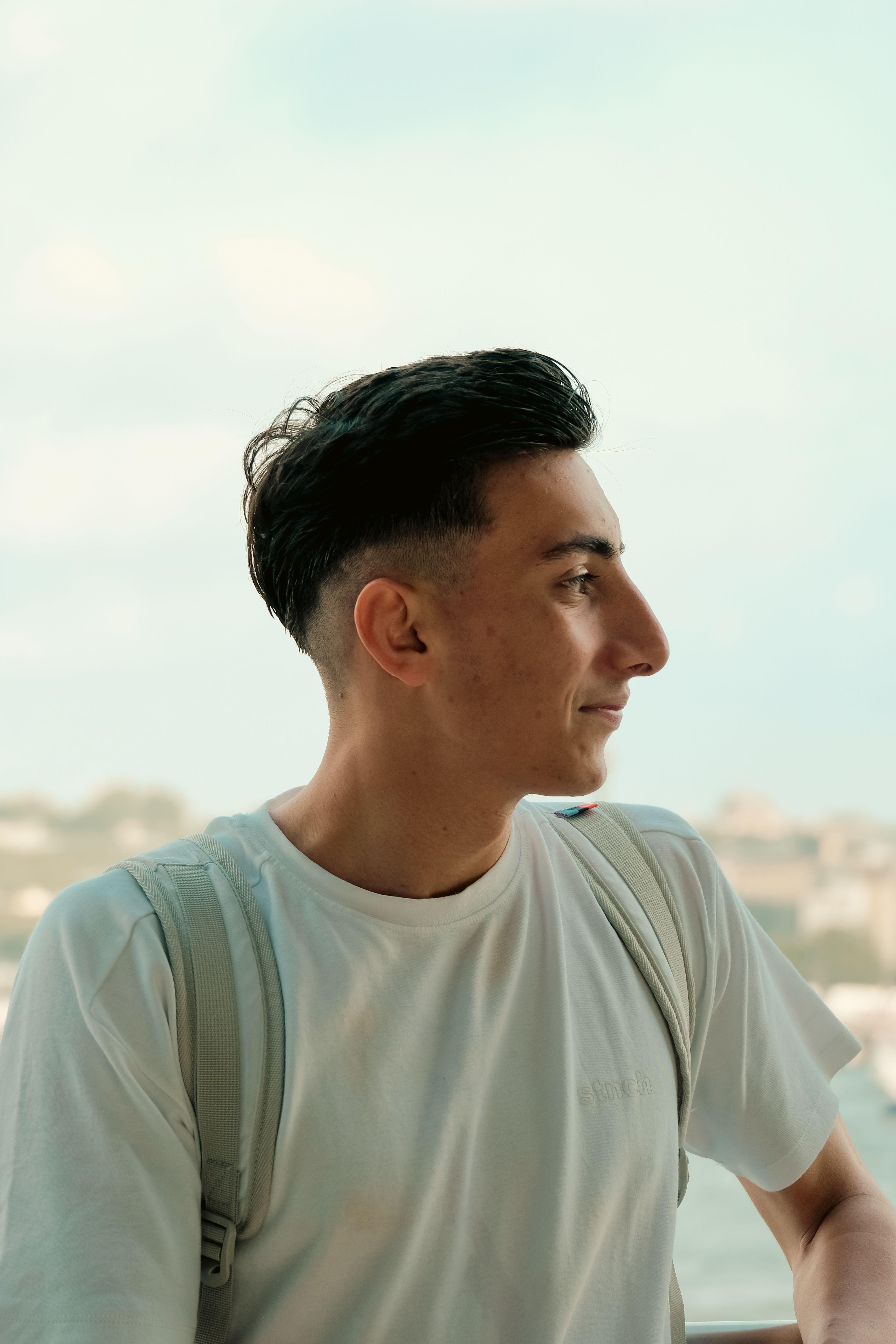 Side View of Young Man Posing Outdoors · Free Stock Photo