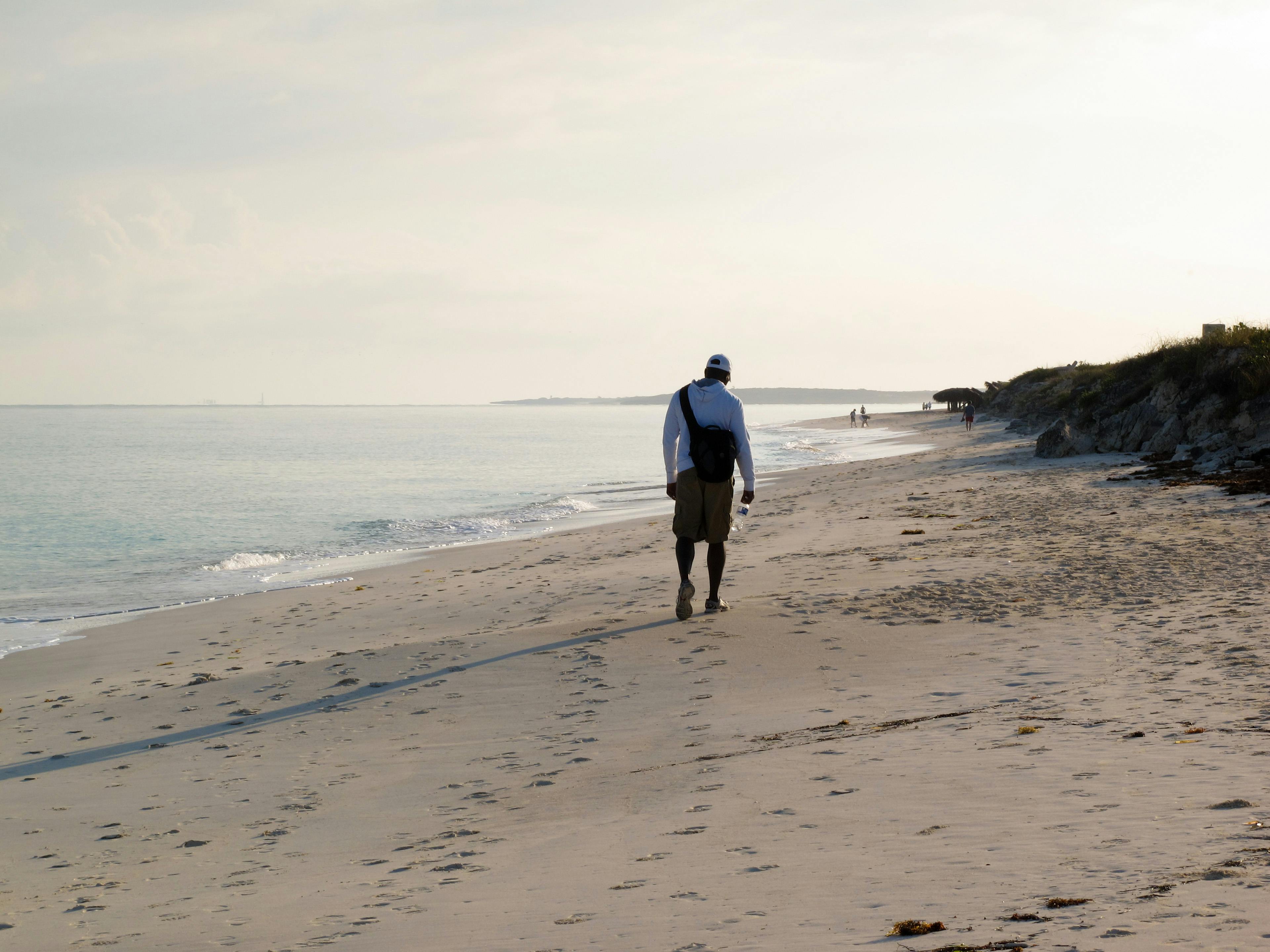 Man Walking on Beach · Free Stock Photo