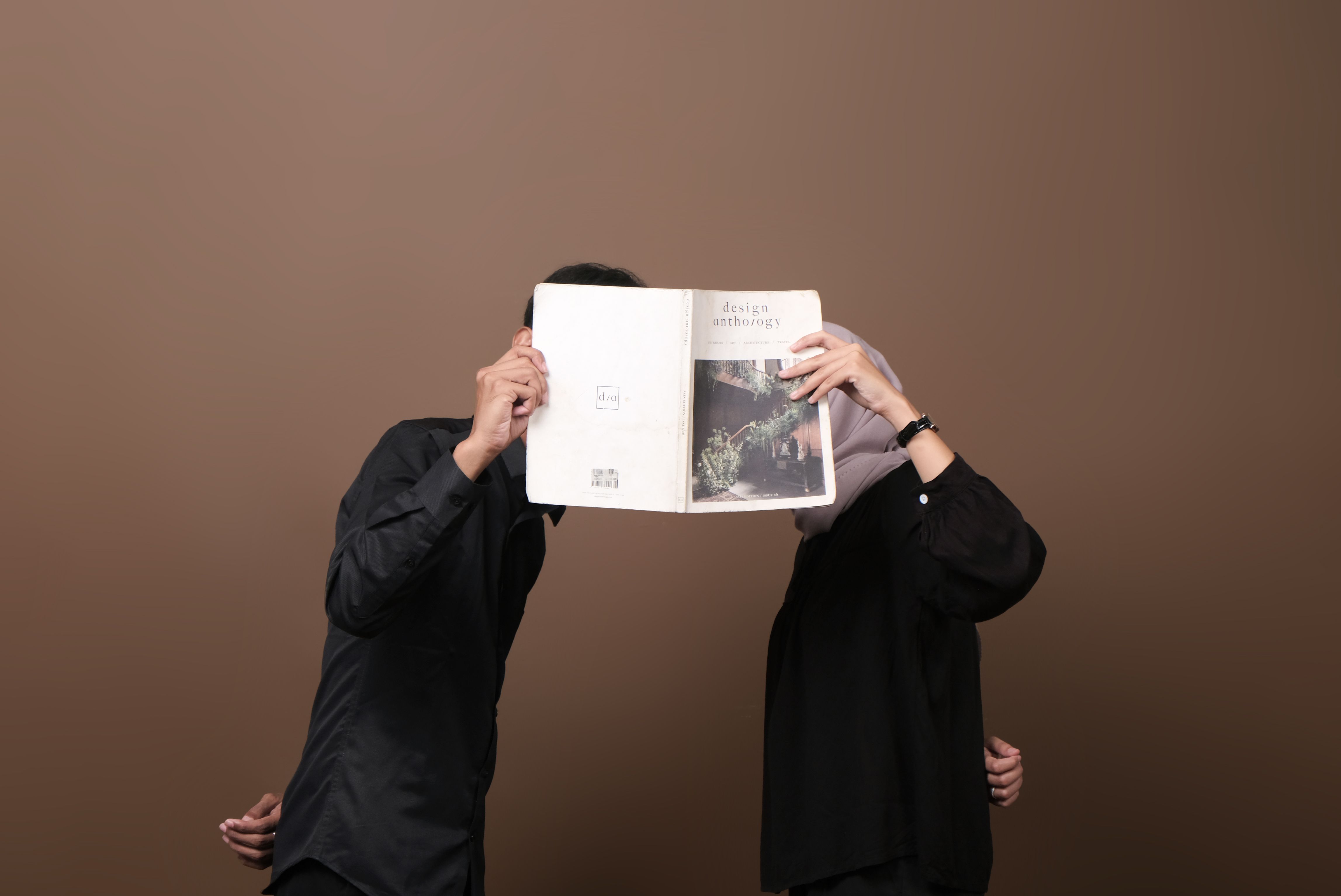 Woman and Man Holding Book Together · Free Stock Photo