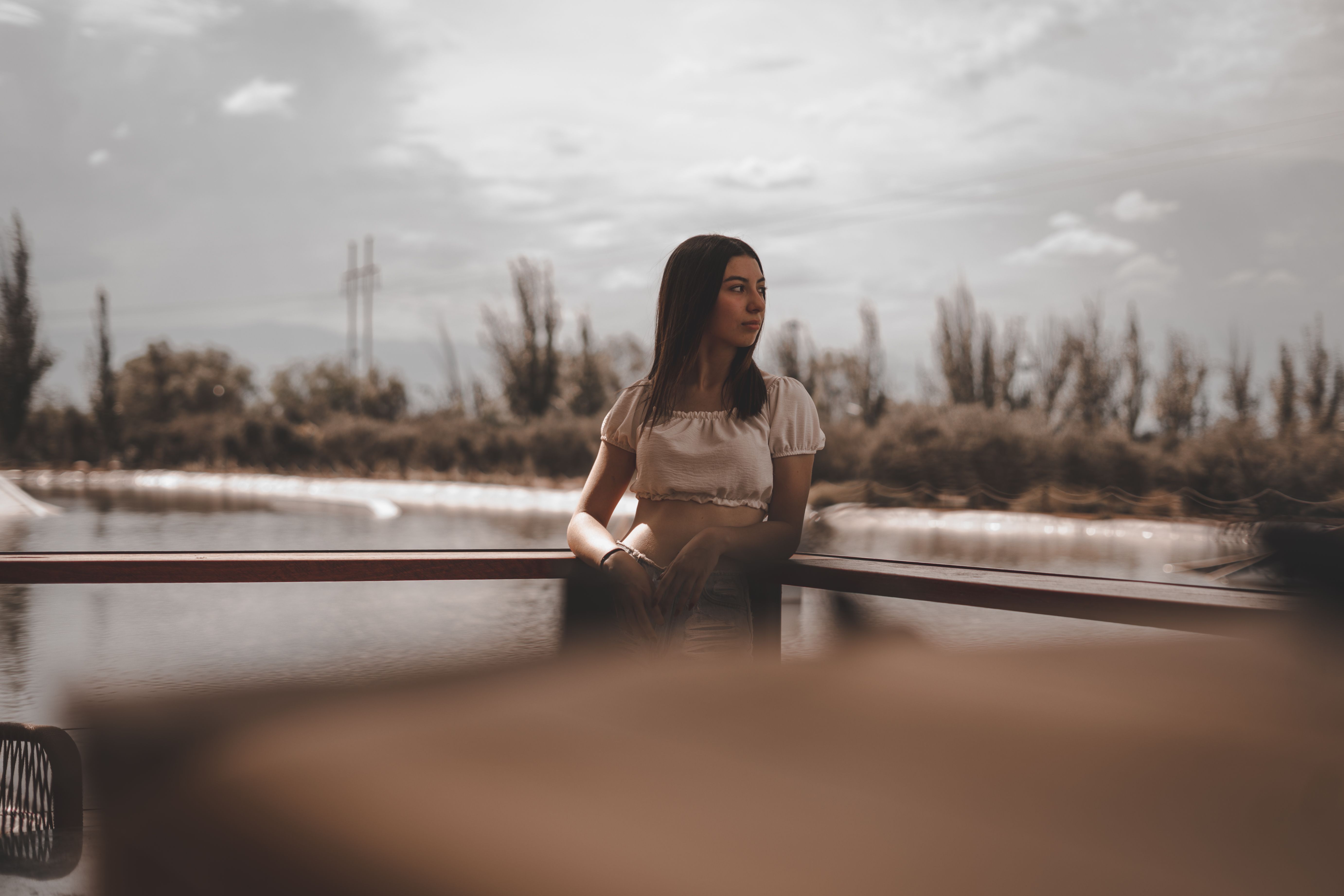 Girl Posing on Terrace near Water · Free Stock Photo