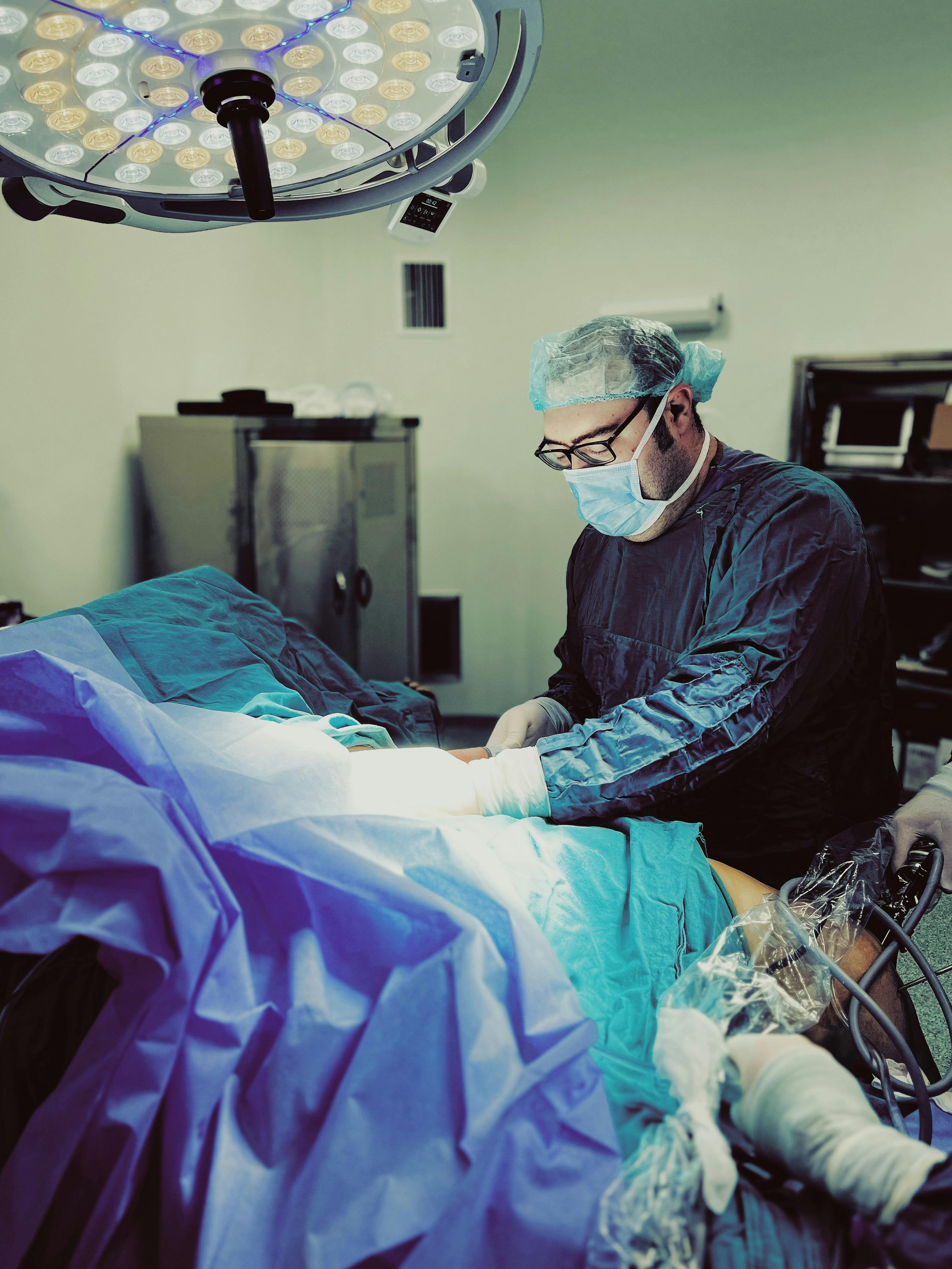 Surgeon Performing a Surgery in an Operating Room · Free Stock Photo