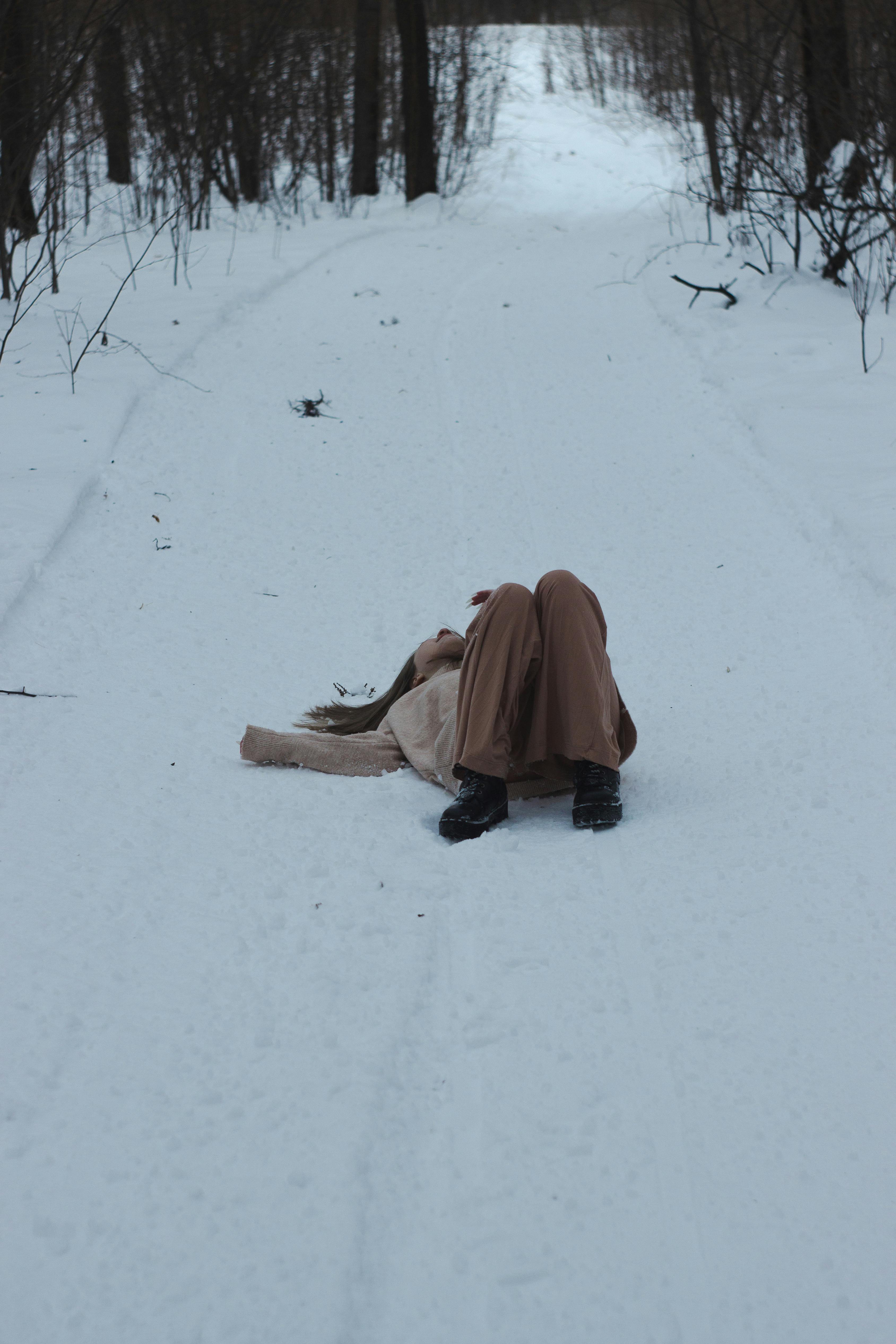 Person Lying Down on Snow · Free Stock Photo