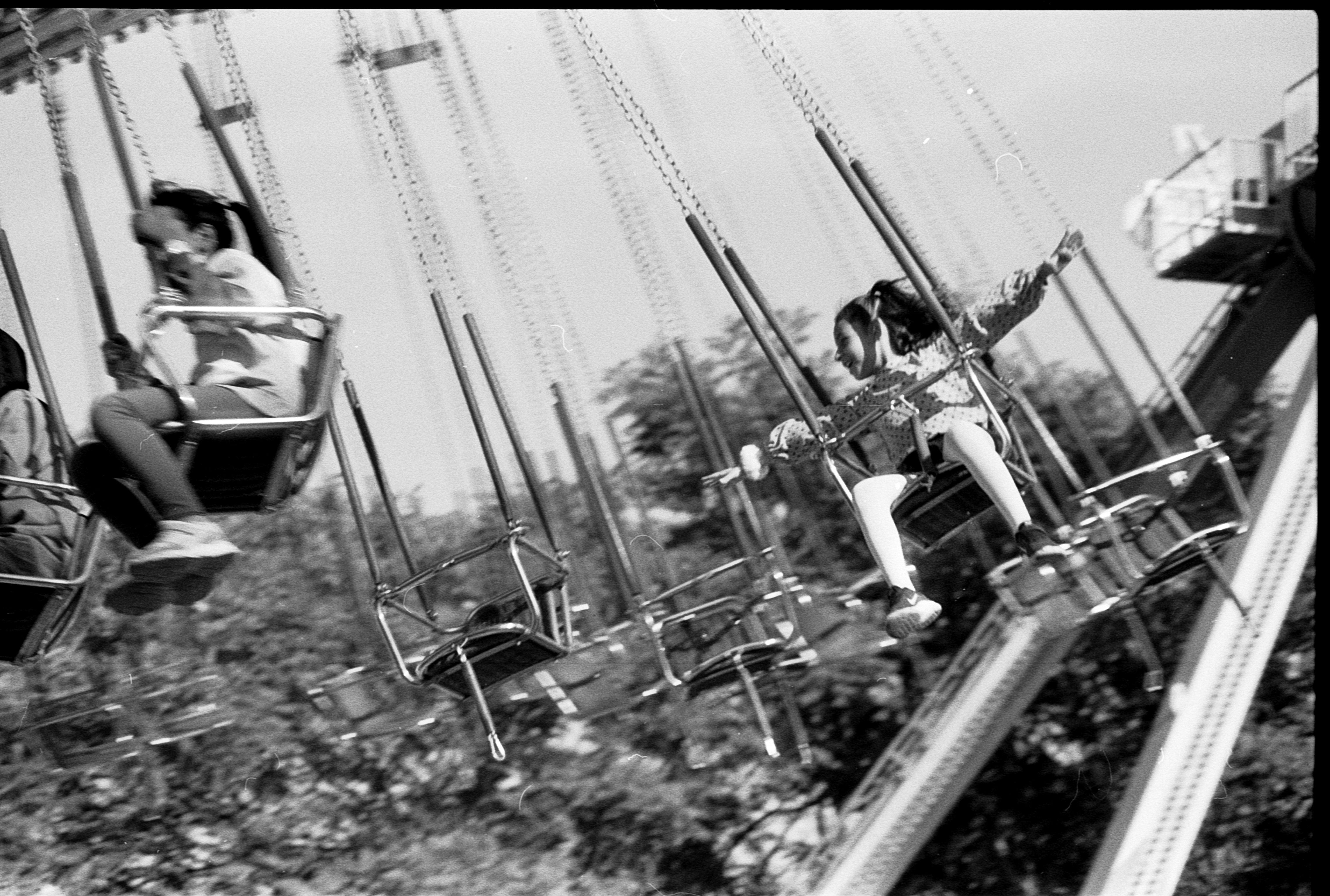 People riding chain carousel in amusement park · Free Stock Photo