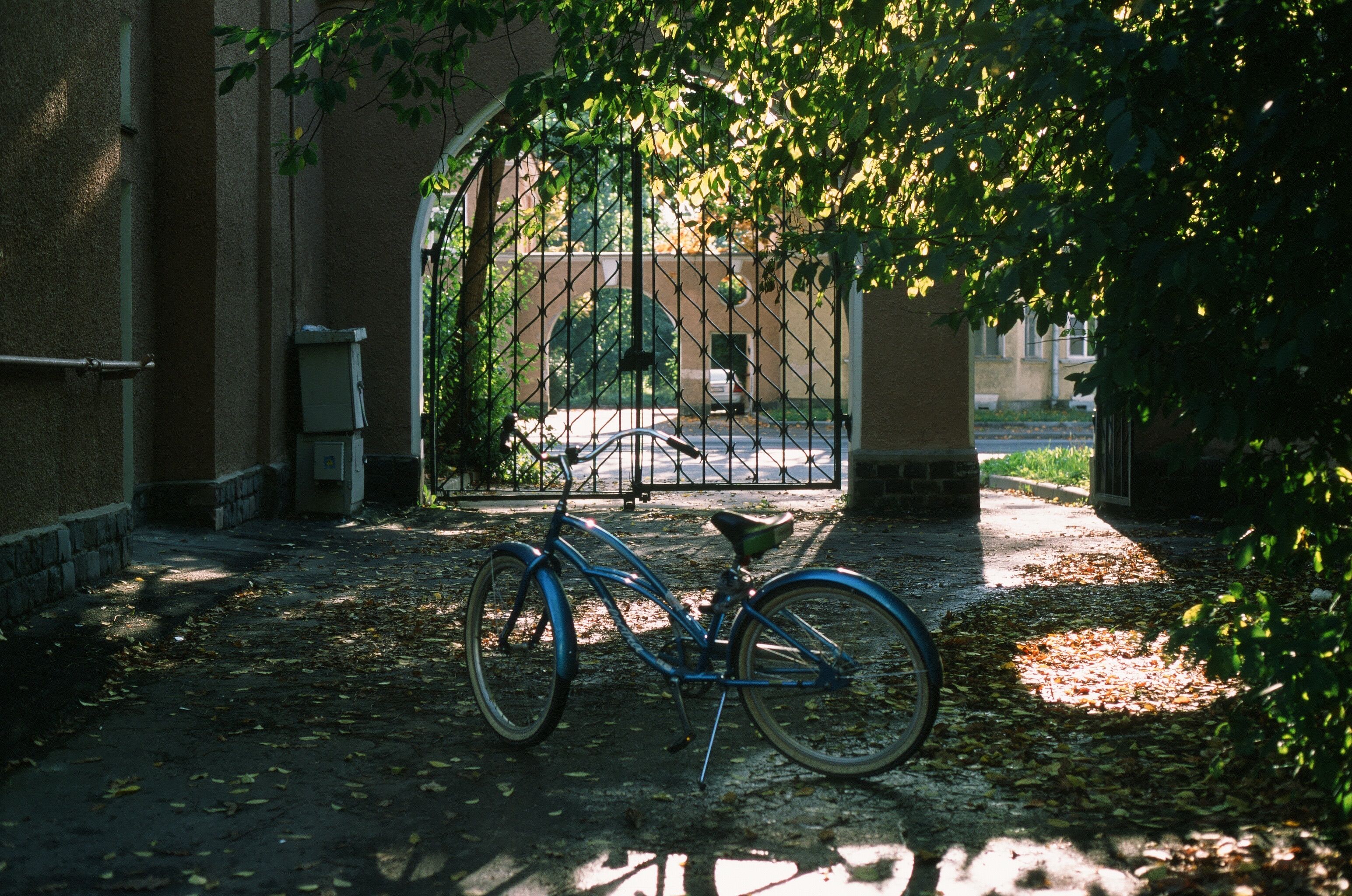 Bicycle Parked near the Metal Gate · Free Stock Photo