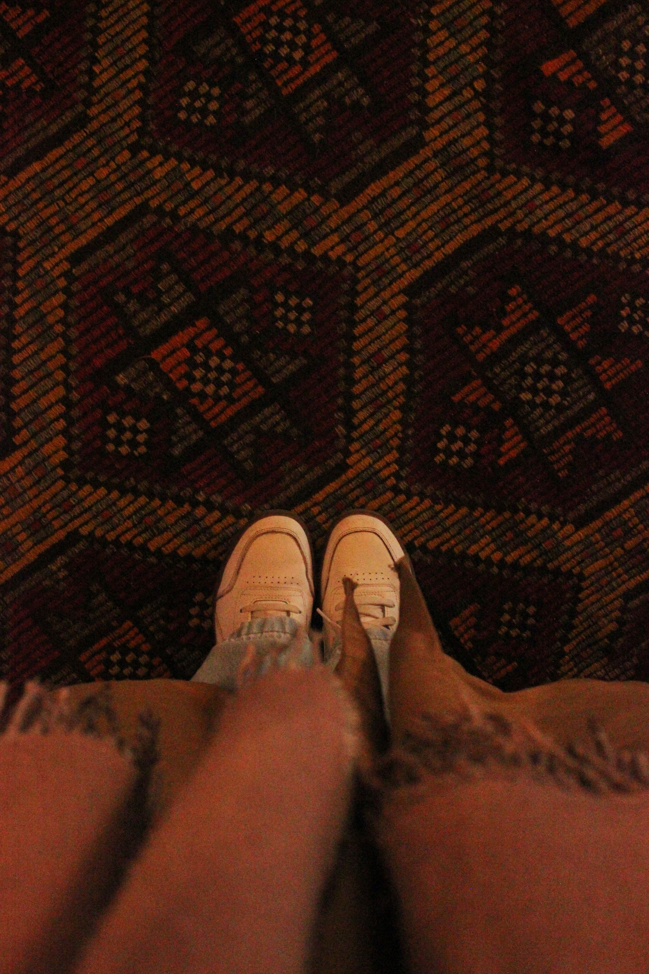 Shoes and Scarf of Person Standing on Carpet · Free Stock Photo