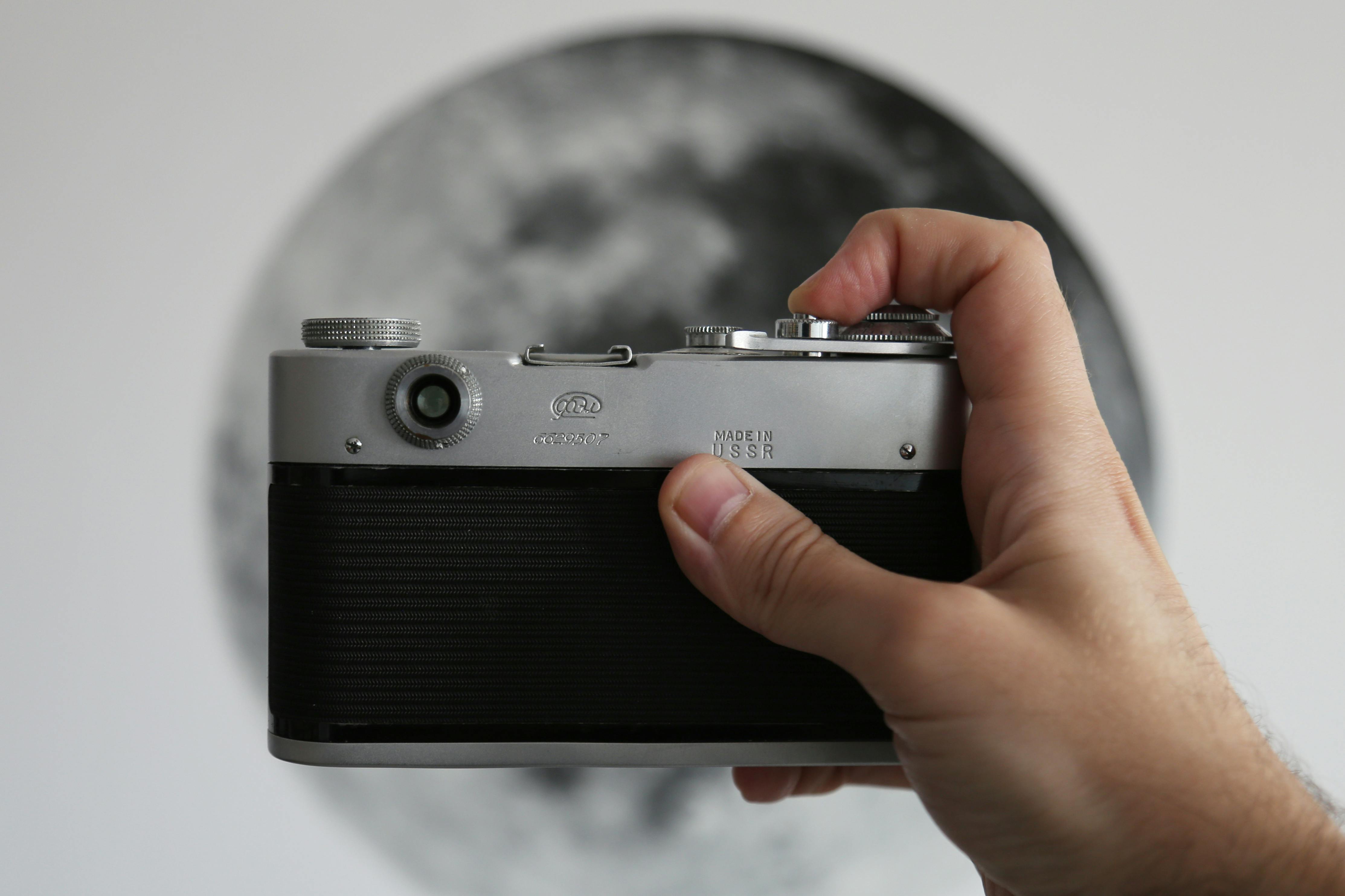 Hand of a Person Holding an Old-Fashioned Camera · Free Stock Photo