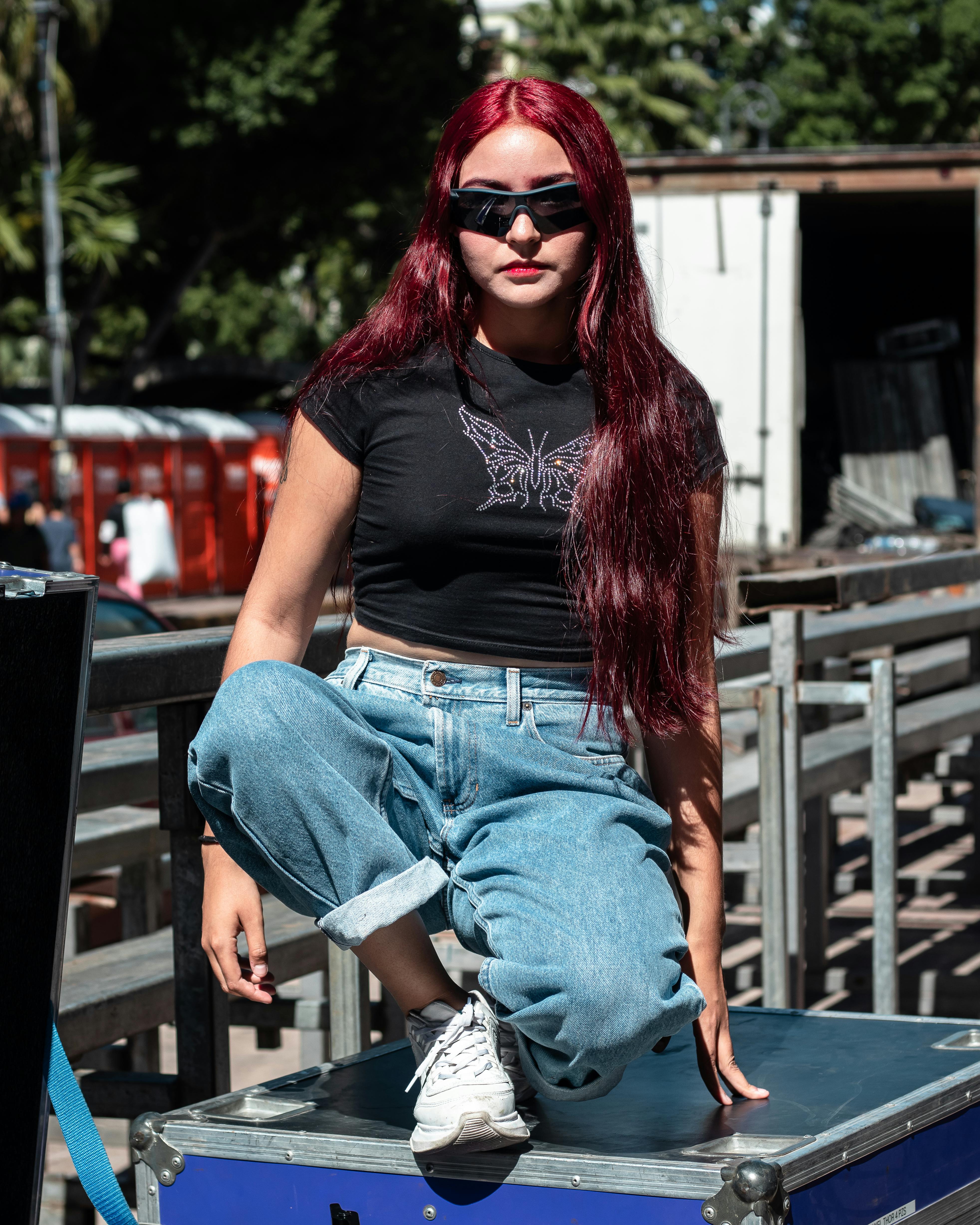 Woman Crouching in Jeans · Free Stock Photo