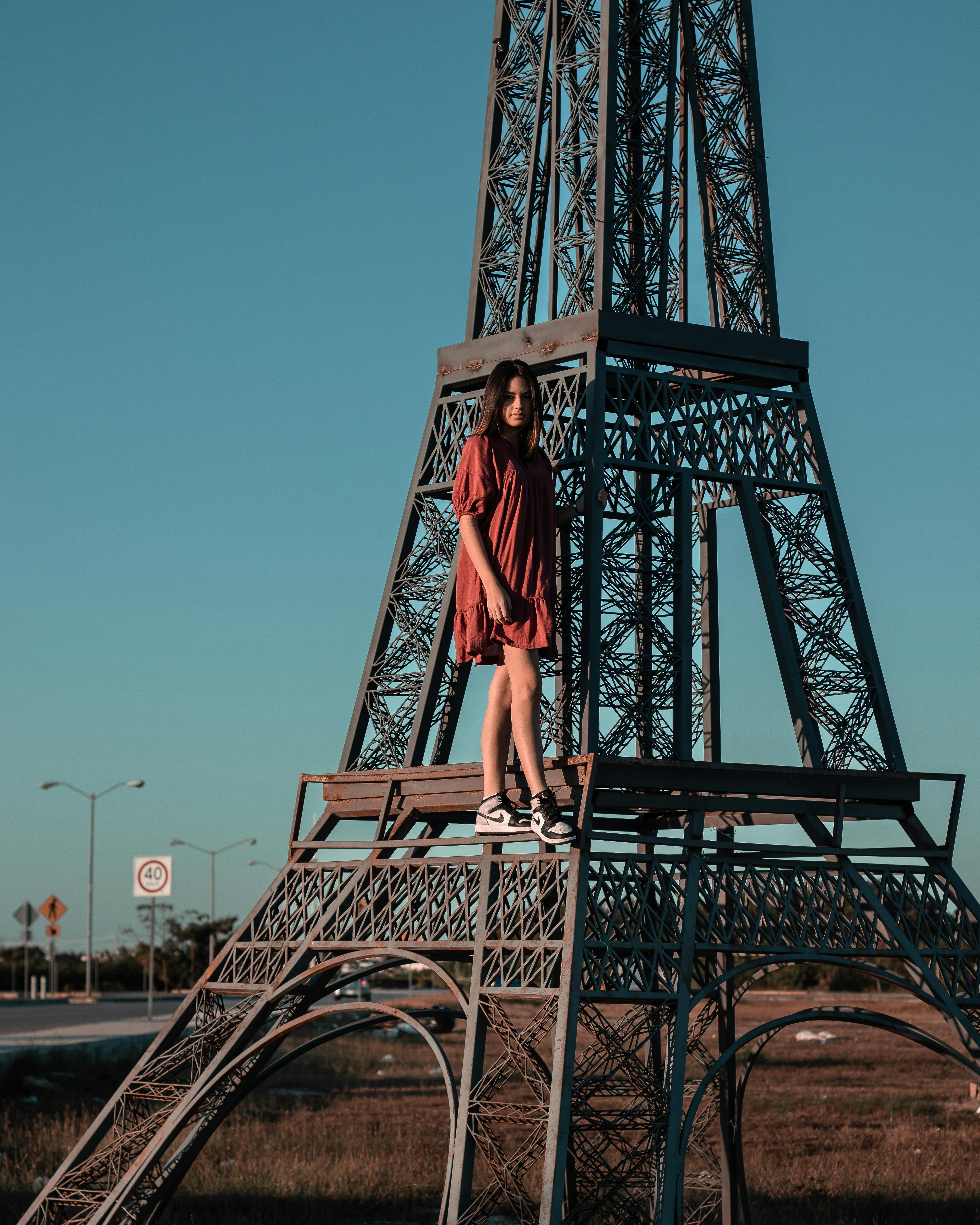Standing Woman and Fake Eiffel Tower · Free Stock Photo