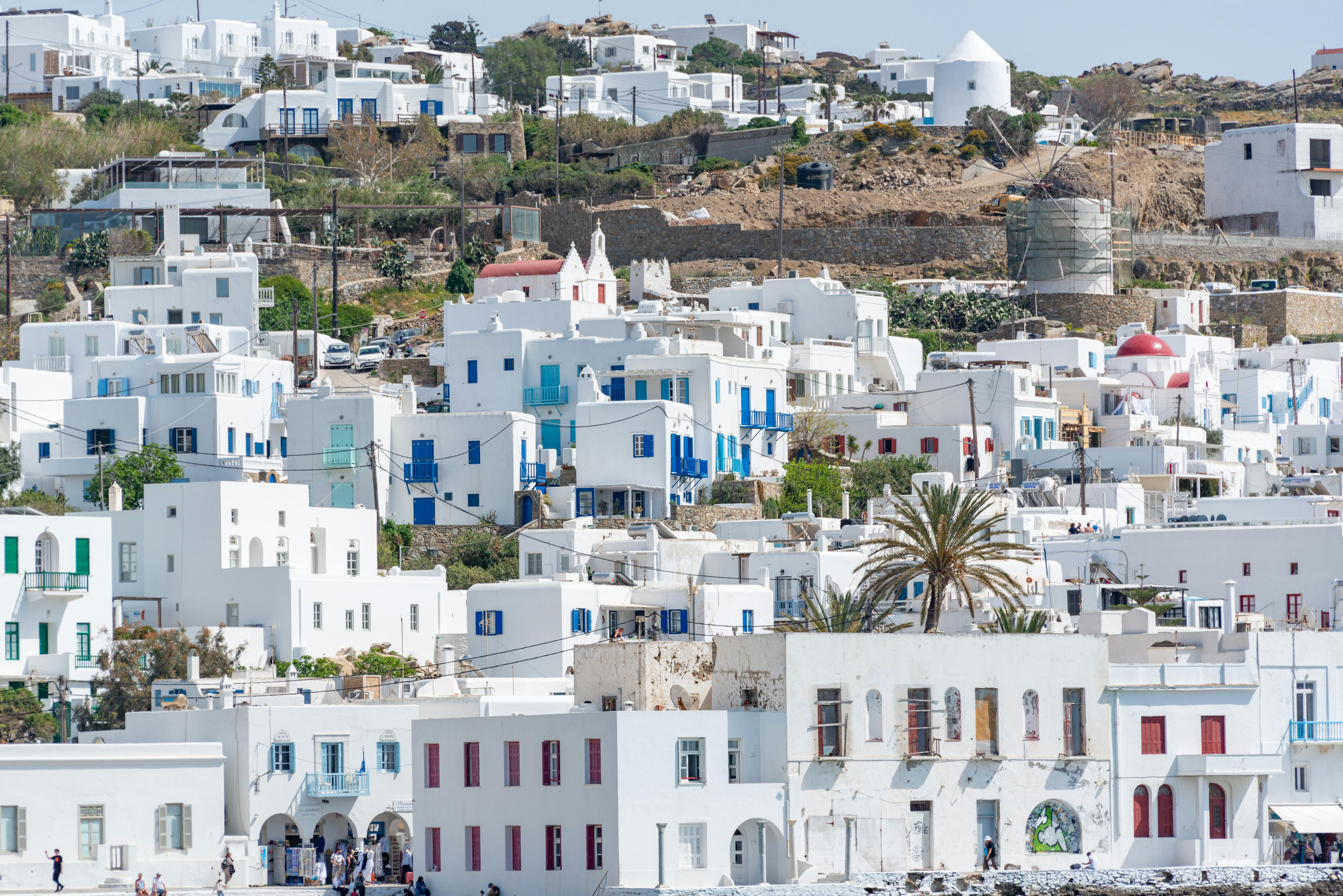 Photo Of White Concrete Buildings Near Body Of Water · Free Stock Photo