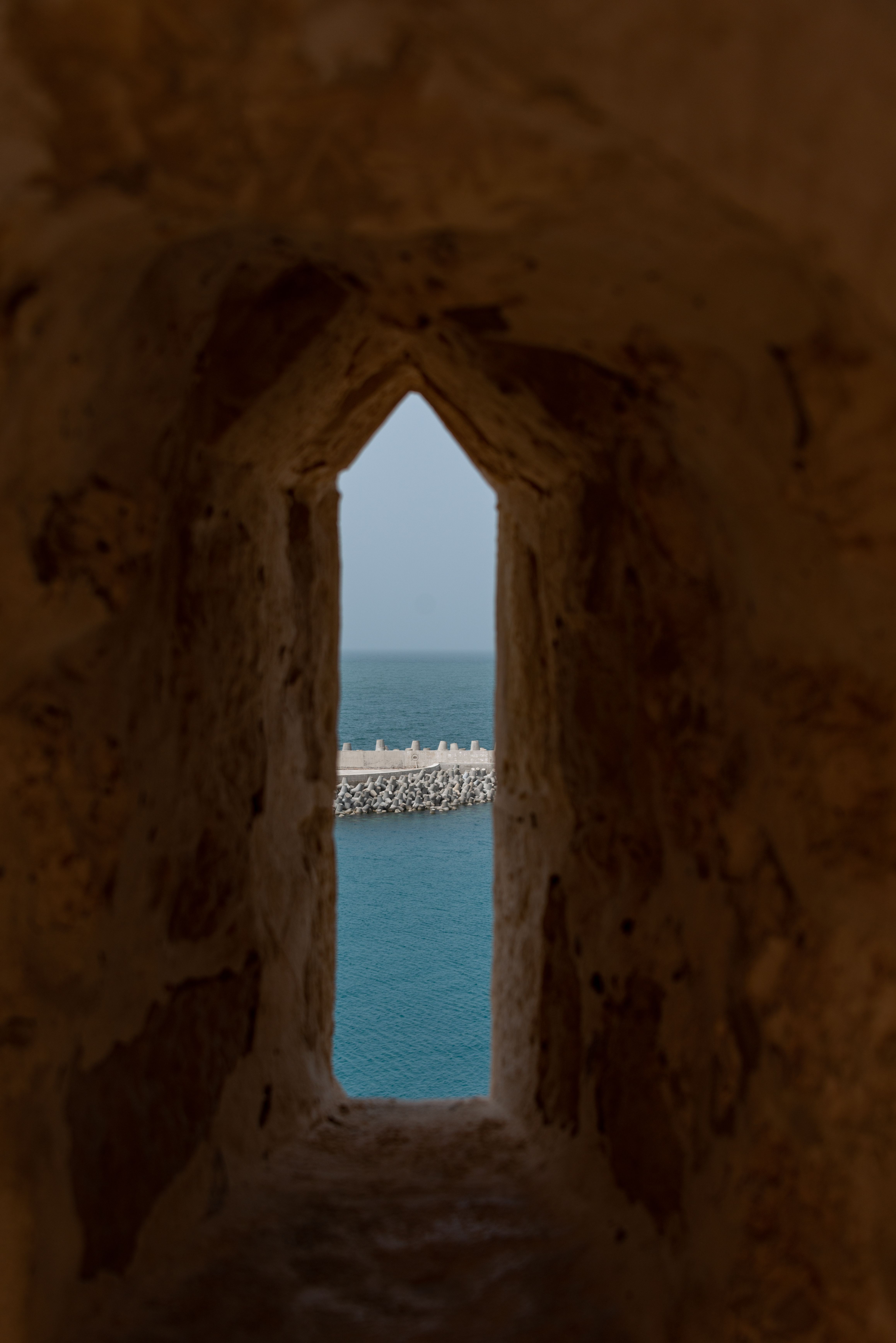 Pier Seen trough Window in Stony Wall · Free Stock Photo