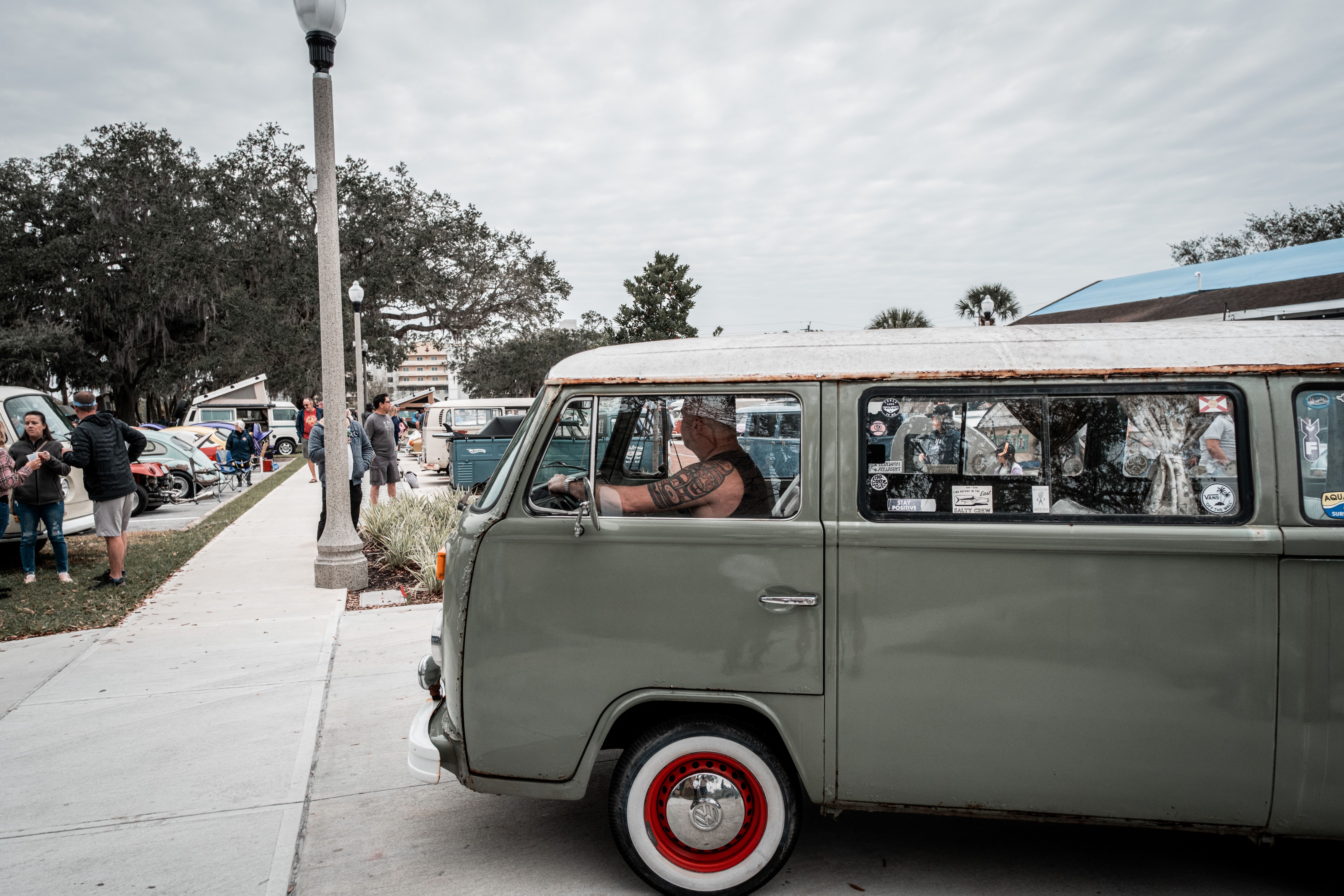 A man is driving a green vw bus · Free Stock Photo