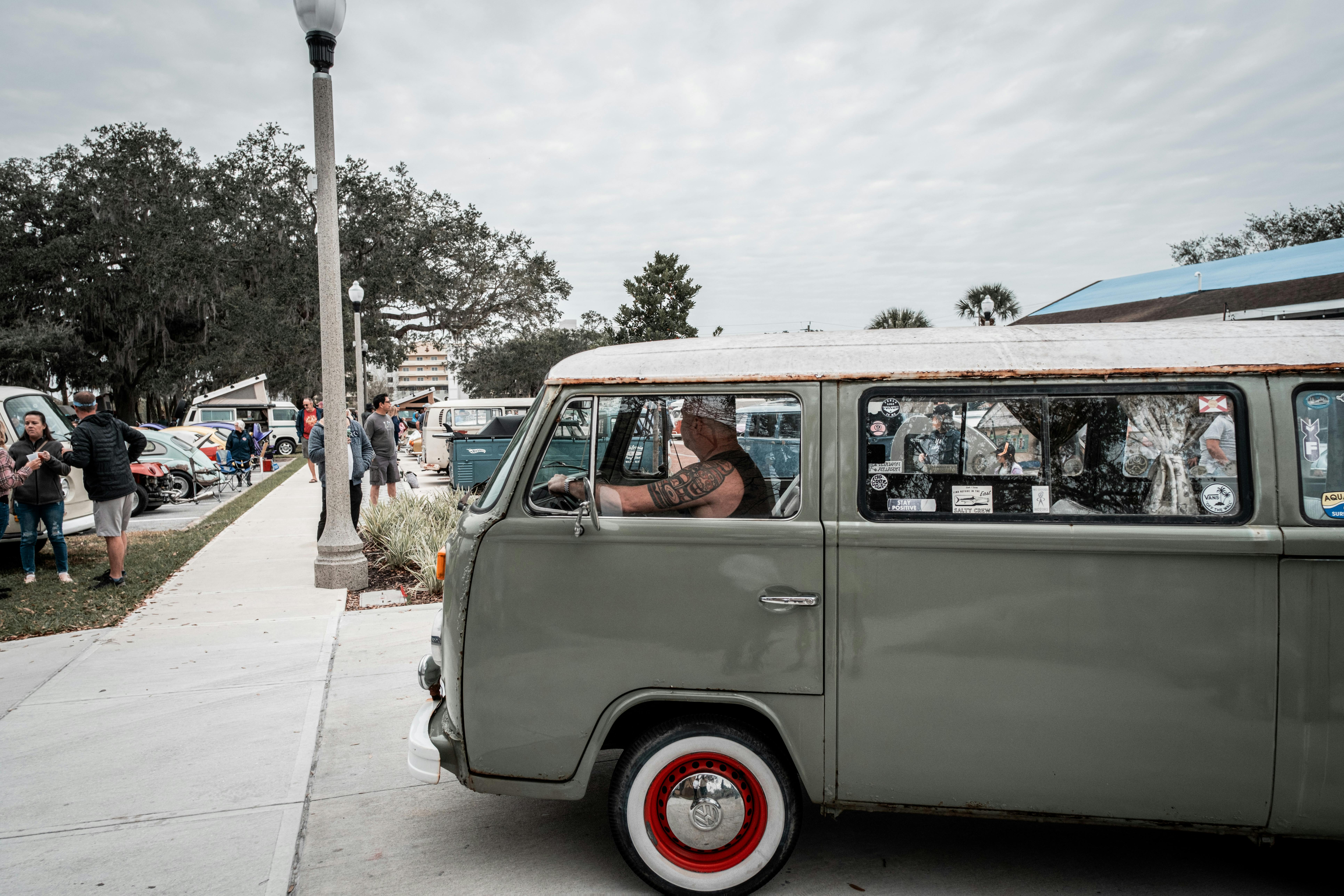 Driver in Green Old-fashioned Volkswagen Mini Van · Free Stock Photo