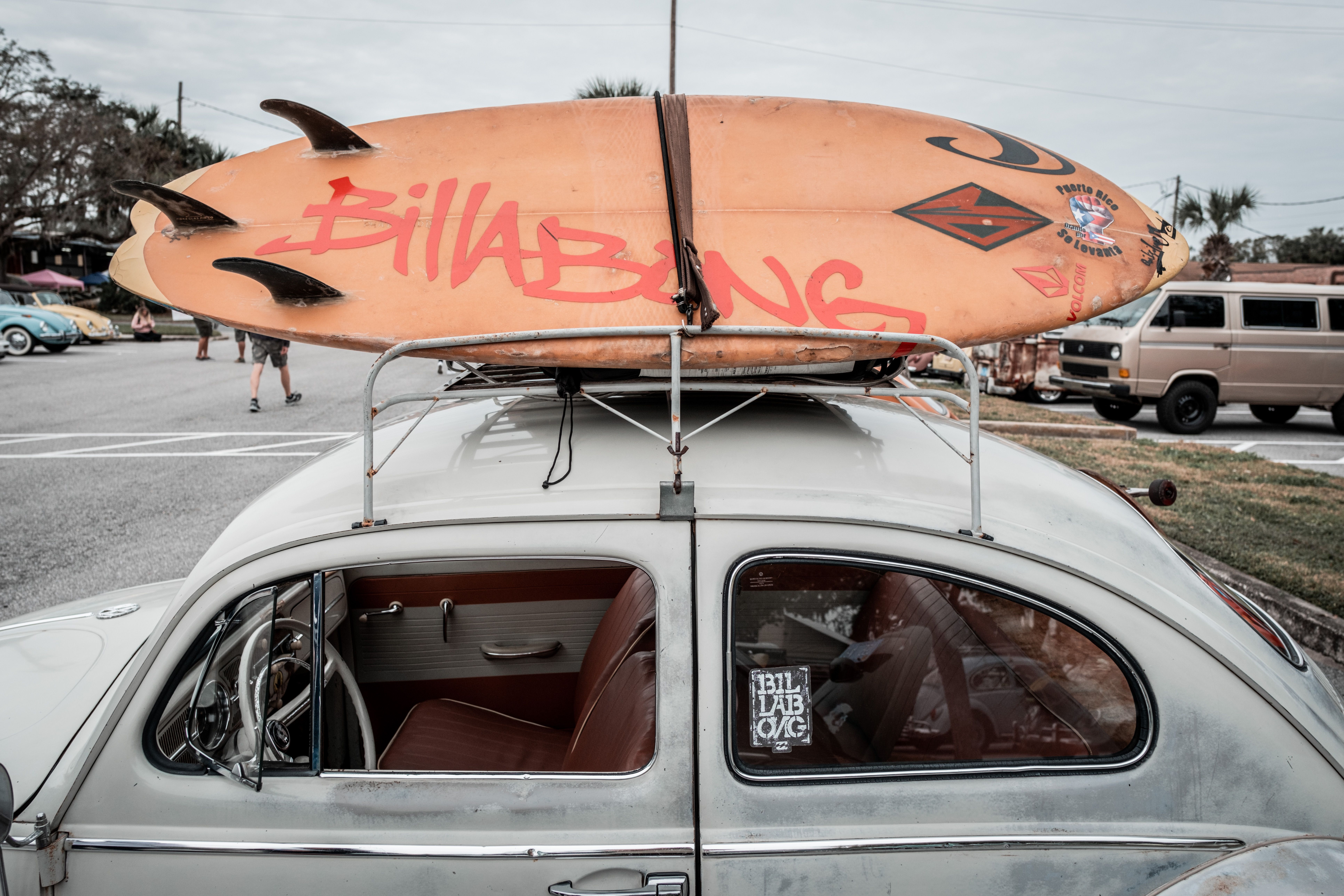 Surfboard on Rooftop of Classic Volkswagen Beetle · Free Stock Photo