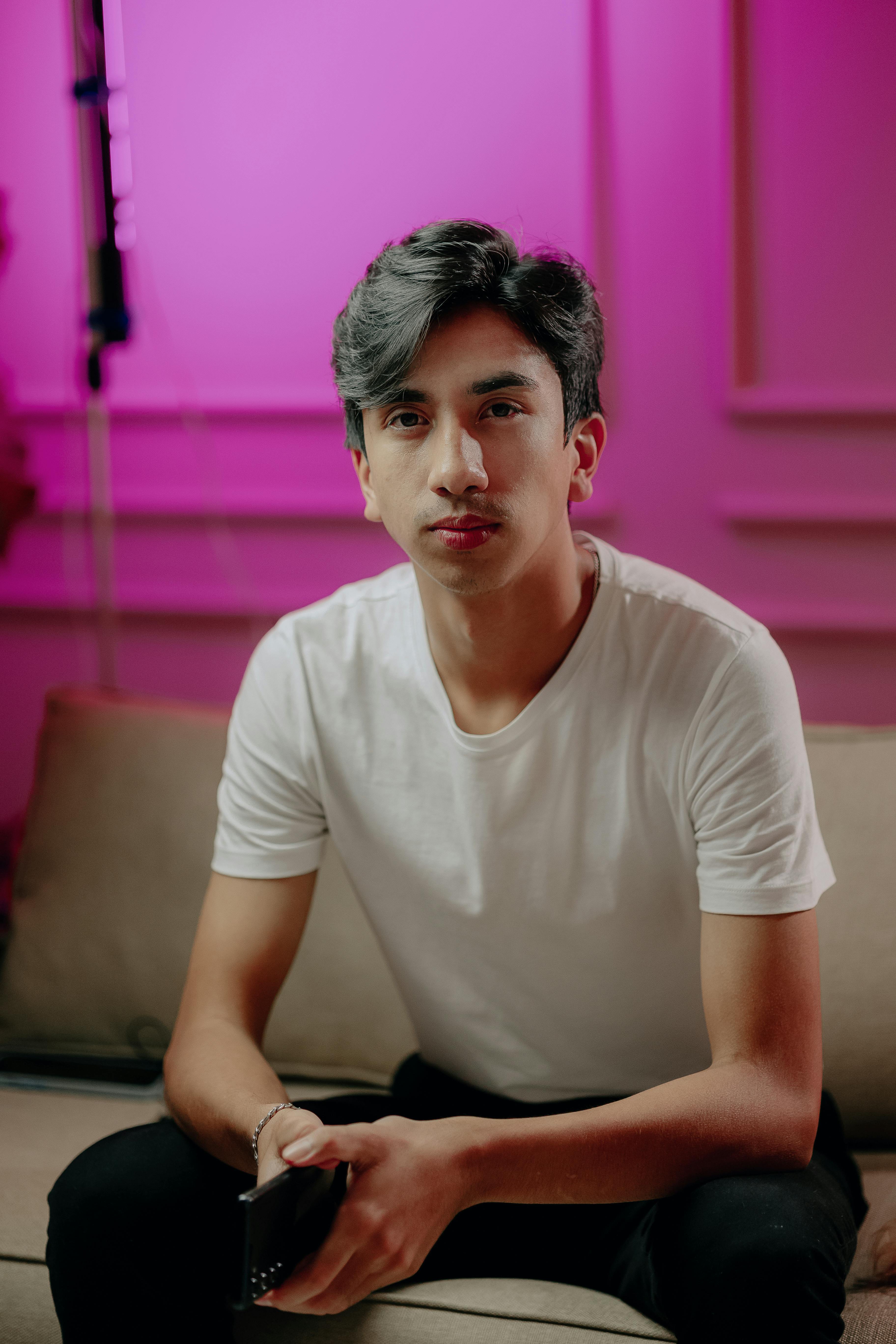 Person in White Shirt Sitting in Dark Room · Free Stock Photo