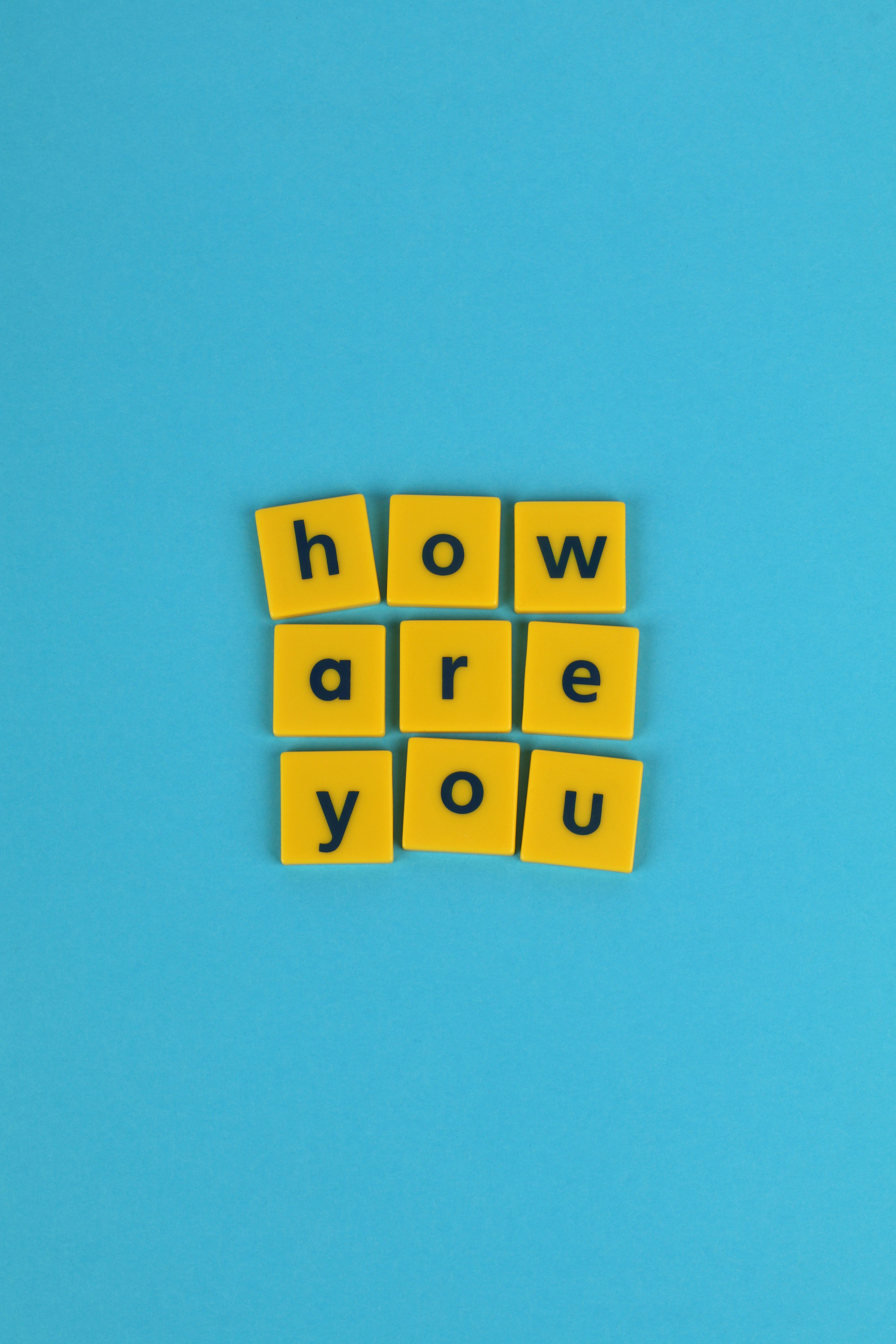 Yellow Letter Tiles Lying on Blue Background and Making a Sign Saying ...