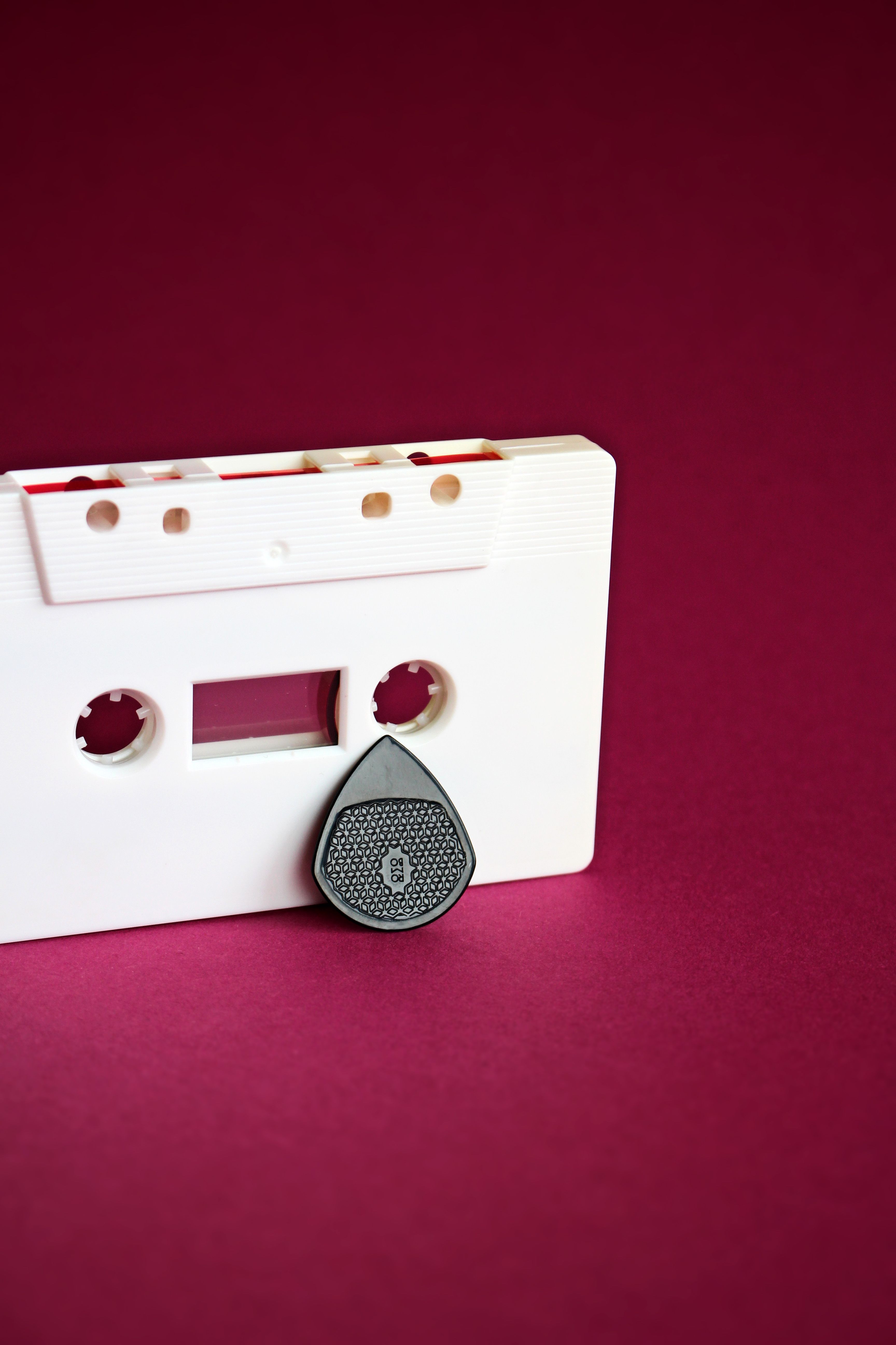 Close-up of a Guitar Pick Leaning against a White Cassette · Free Stock ...