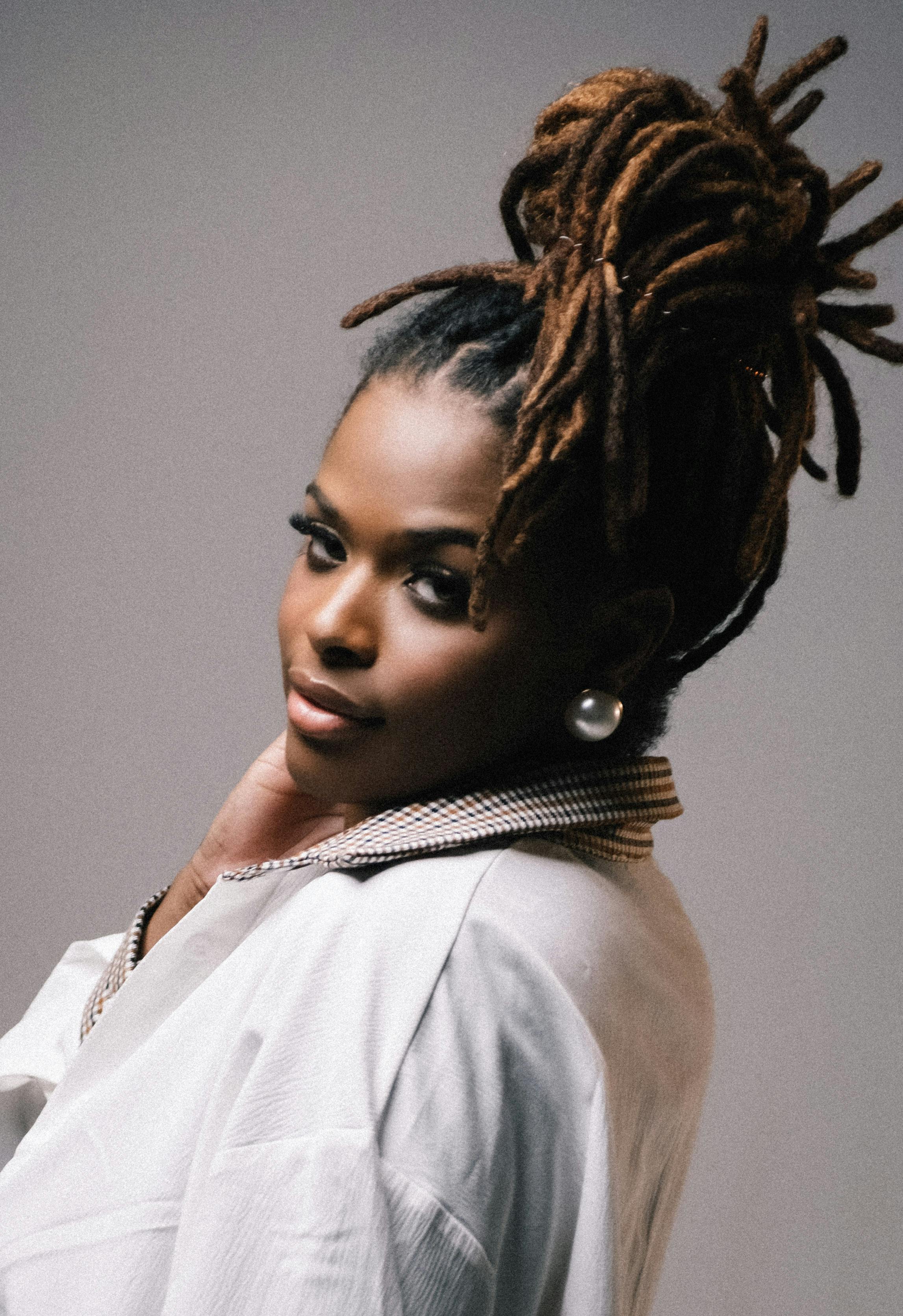 Portrait of a Woman Looking Over Her Shoulder · Free Stock Photo