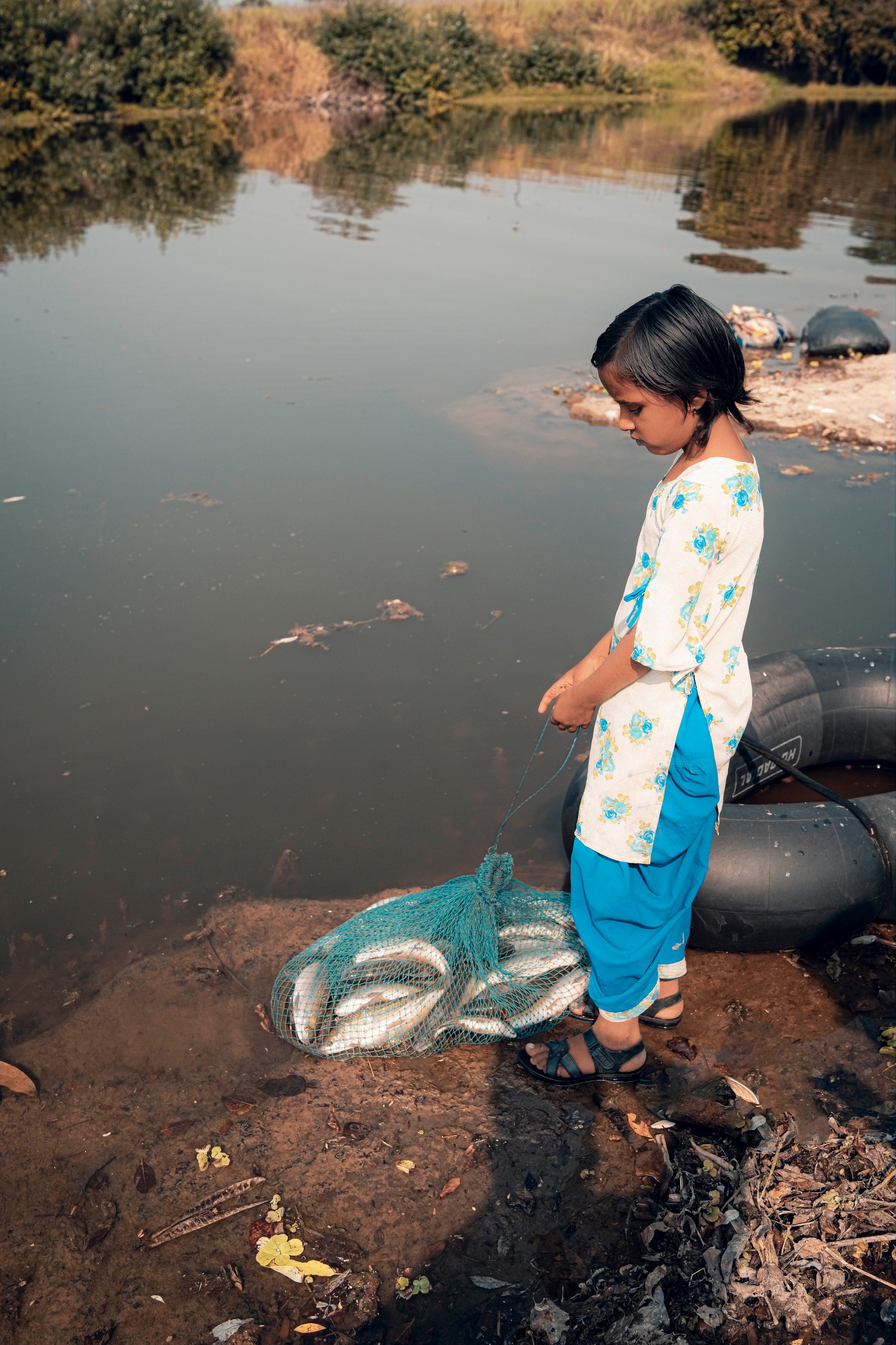 Girl with Net with Fish by River · Free Stock Photo