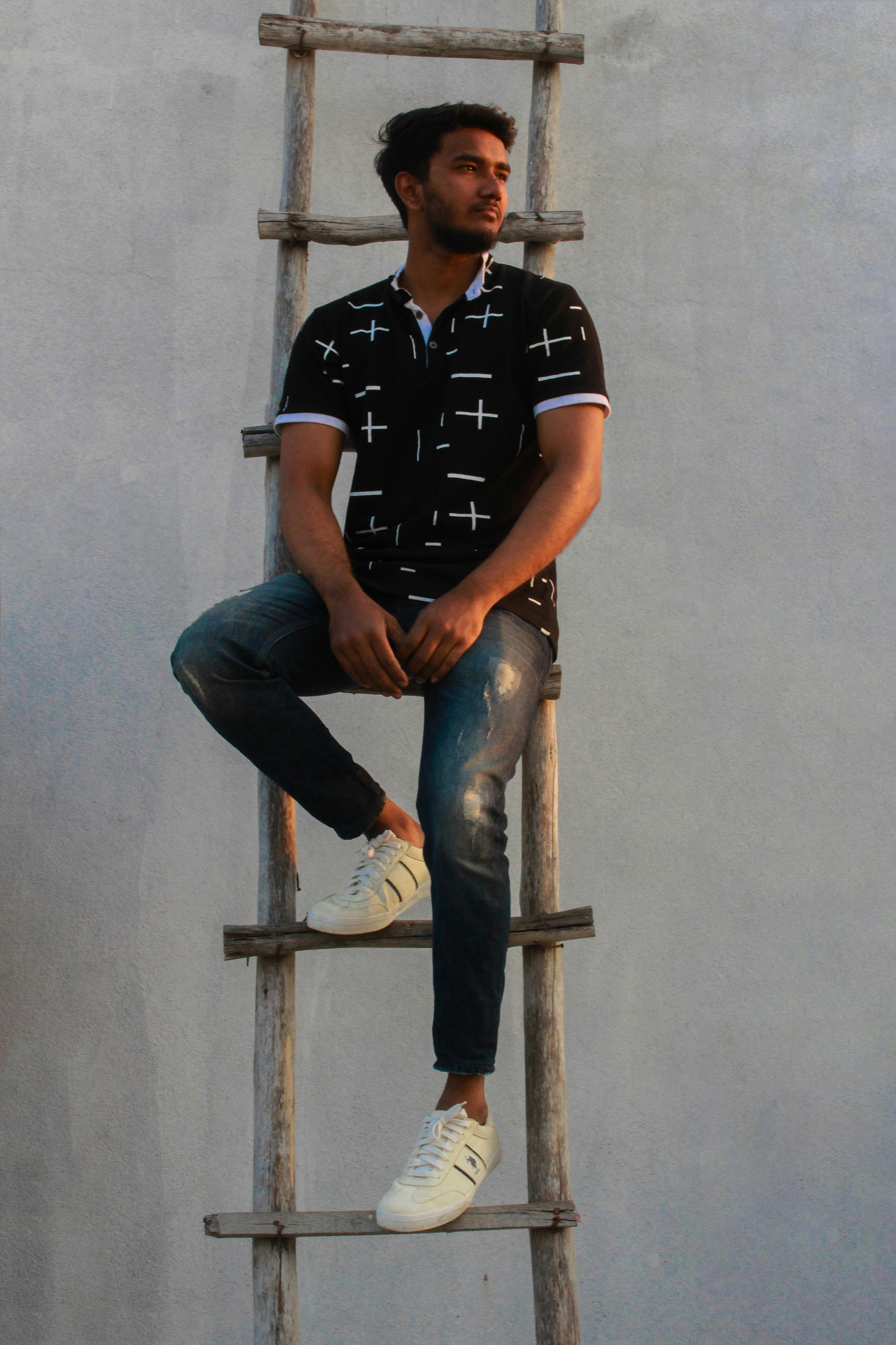 A Man Sitting on Wooden Ladder · Free Stock Photo
