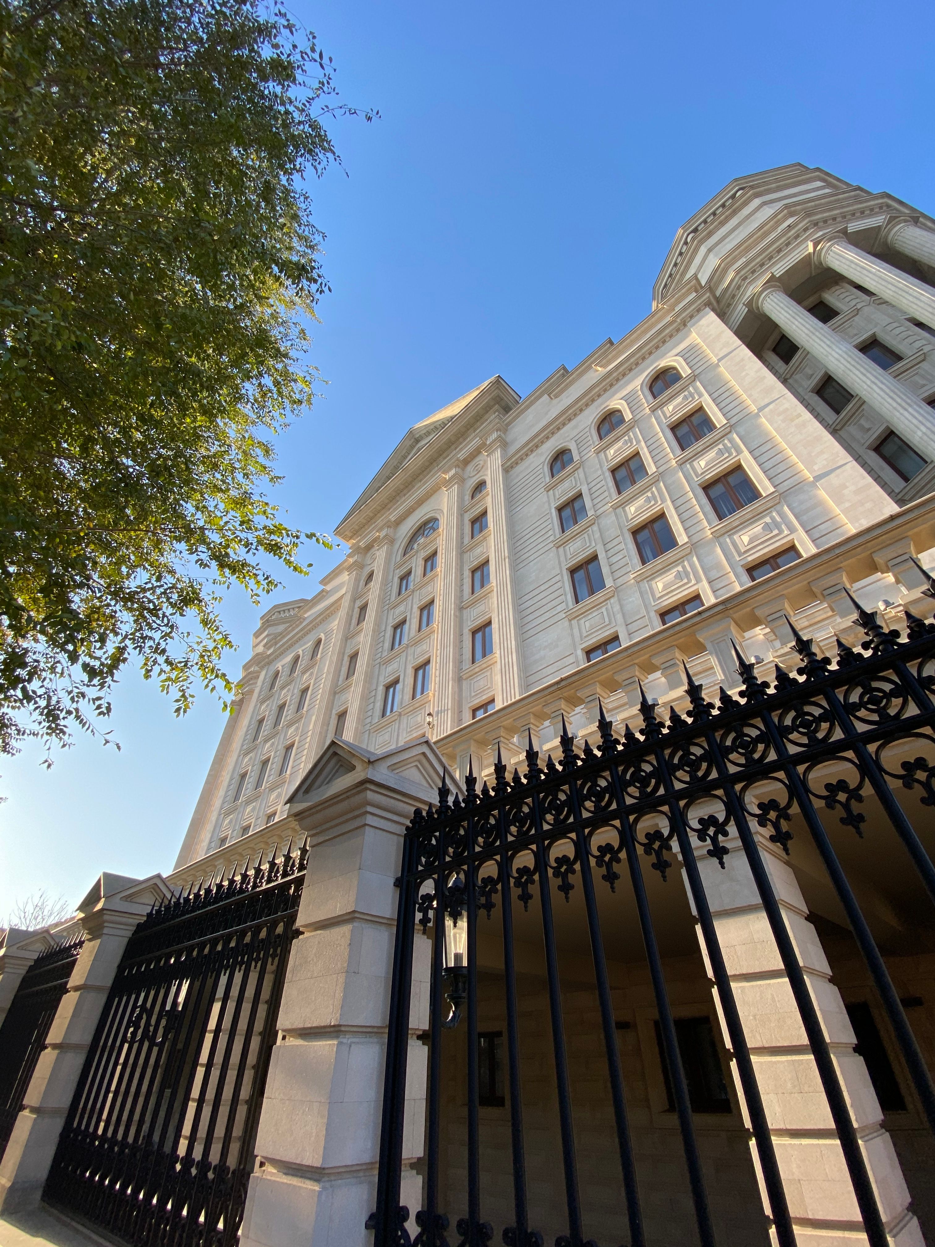 Gates with Columns near Classic Residential Building · Free Stock Photo