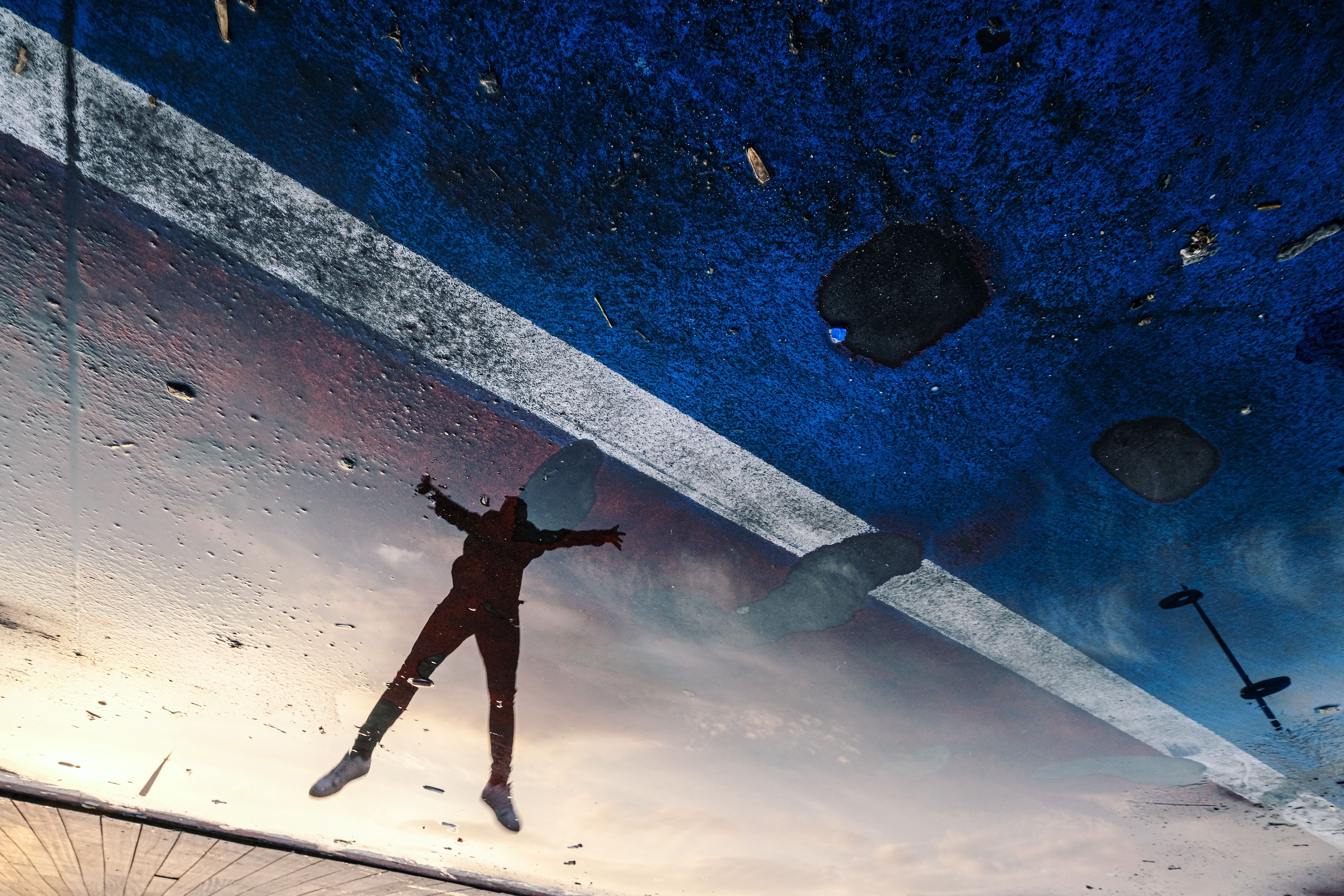 Reflection of a Person in a Puddle · Free Stock Photo
