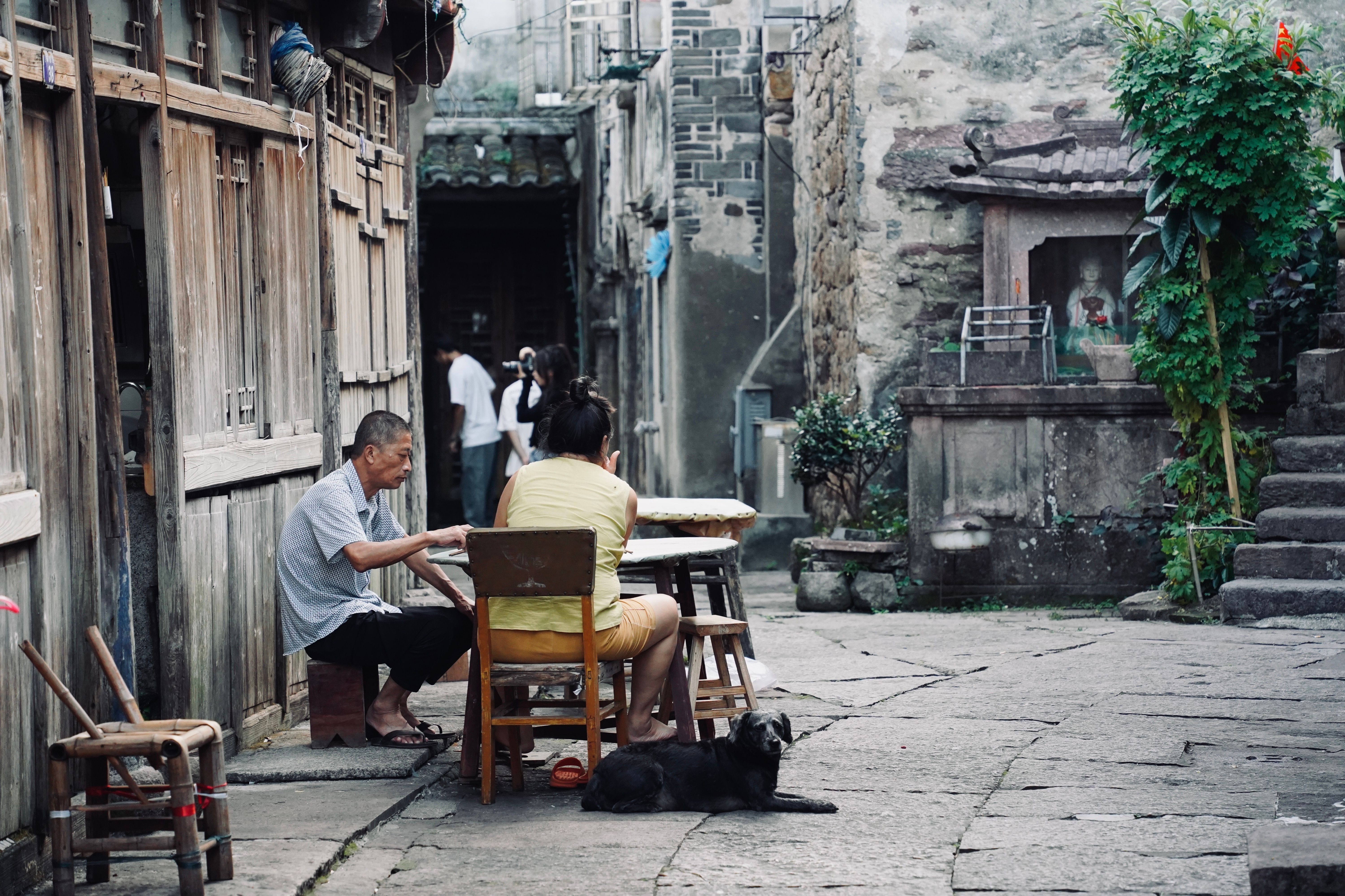 People Sitting at Table on Street in Old Town · Free Stock Photo