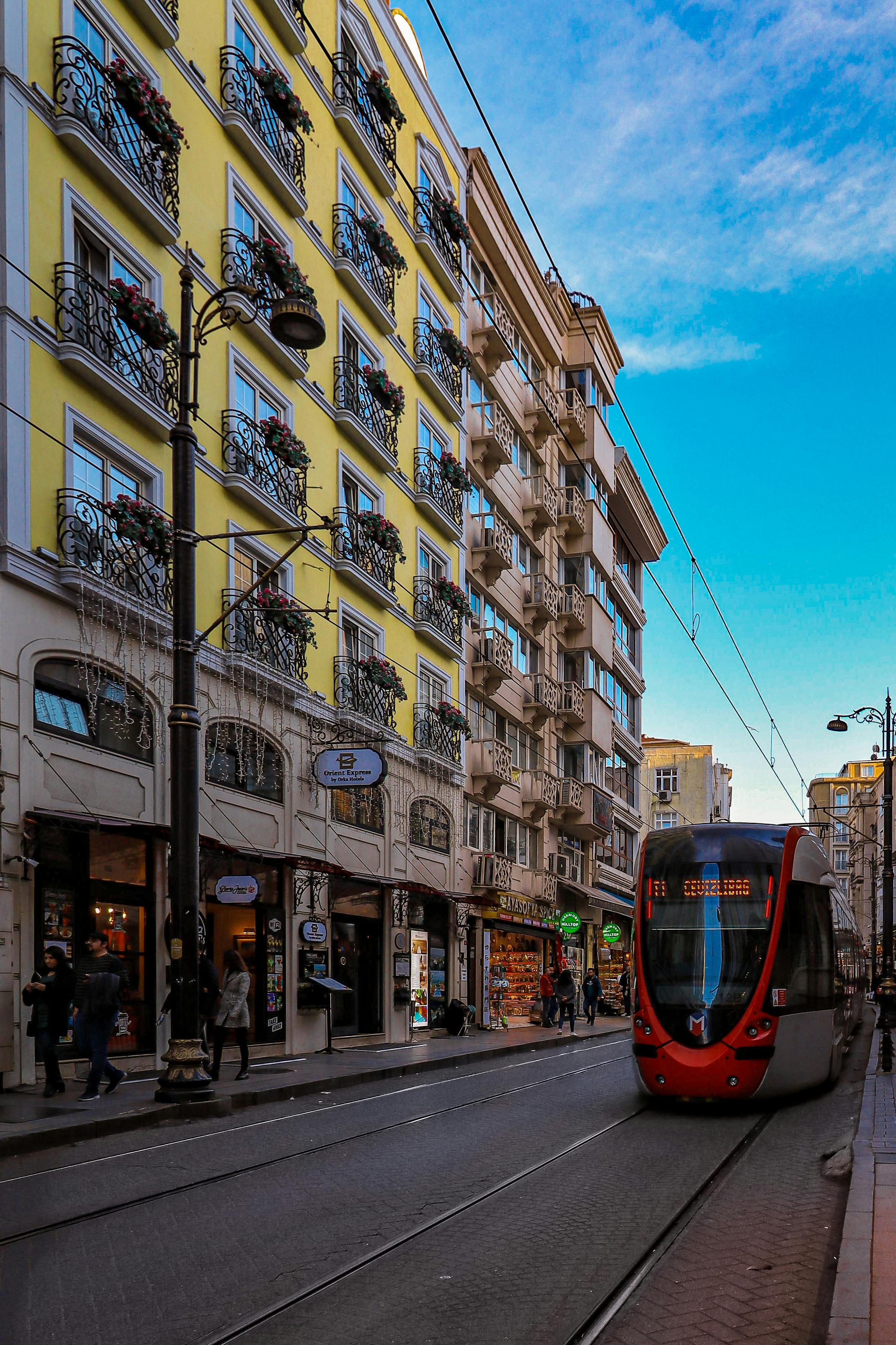 A Tram on a City Street and the Front of a Residential Building · Free ...