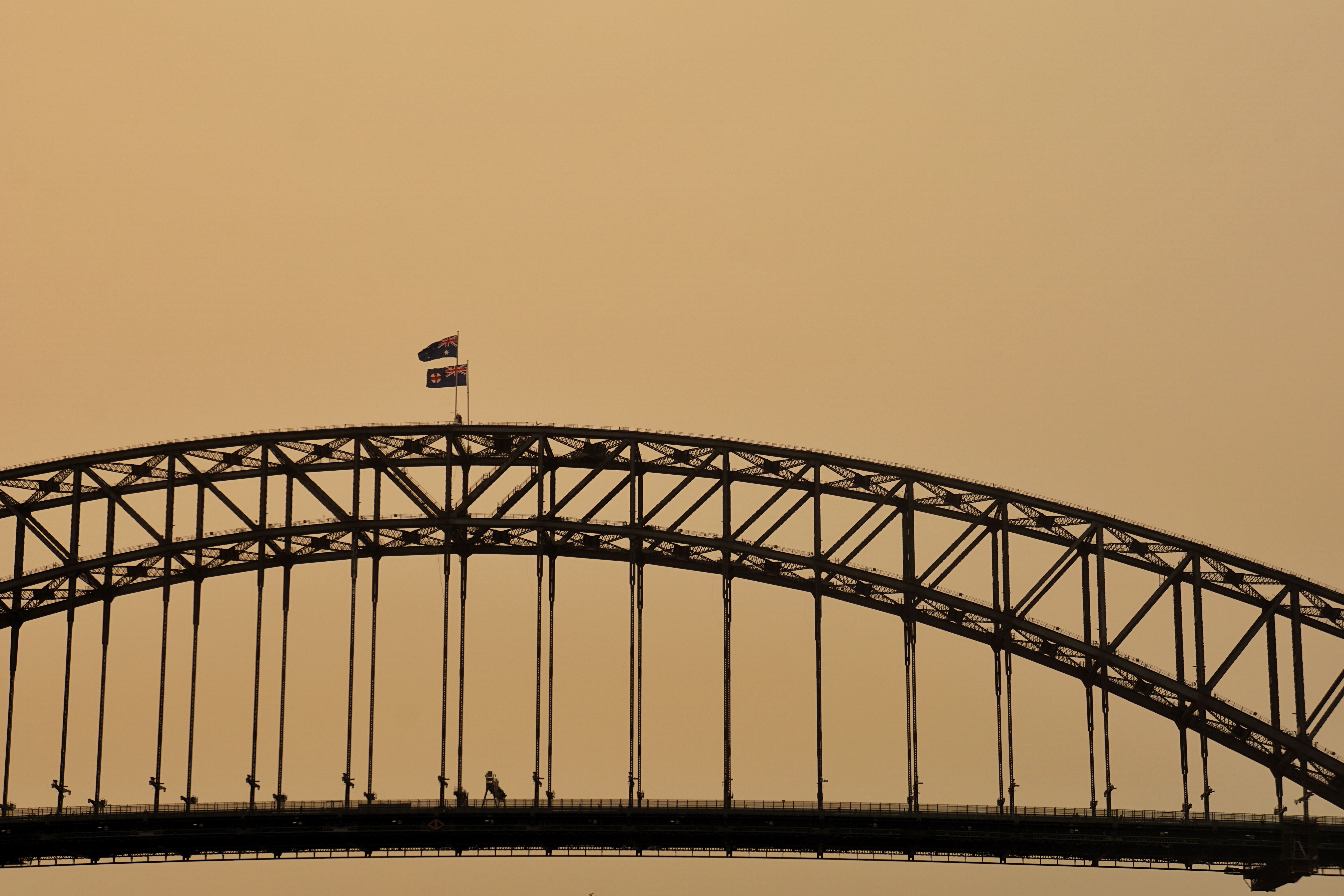 Australian flags placed on Sydney Harbor Bridge arch in twilight · Free ...