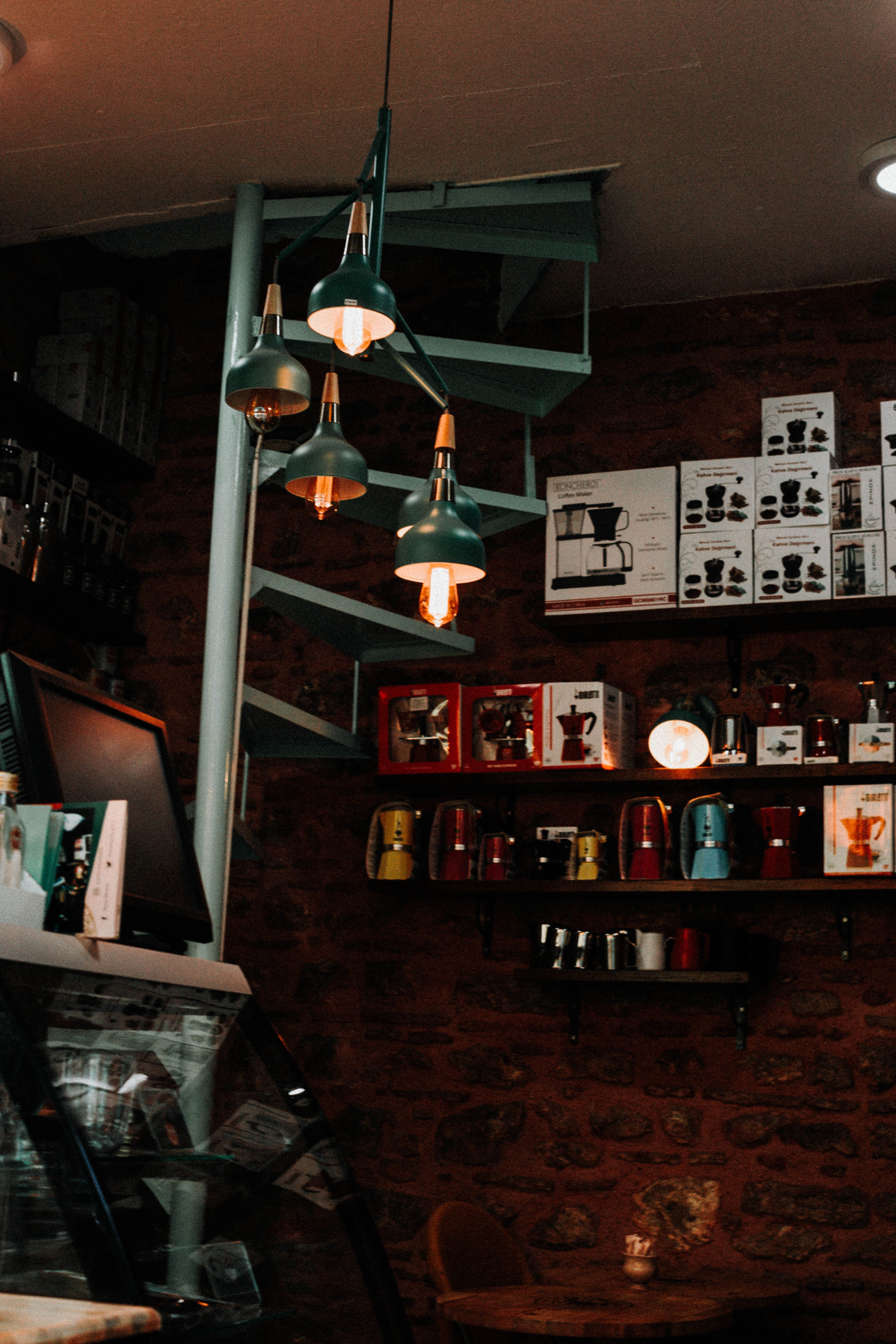Interior of Coffee Shop with Pendant Lamps and Display on Wooden ...
