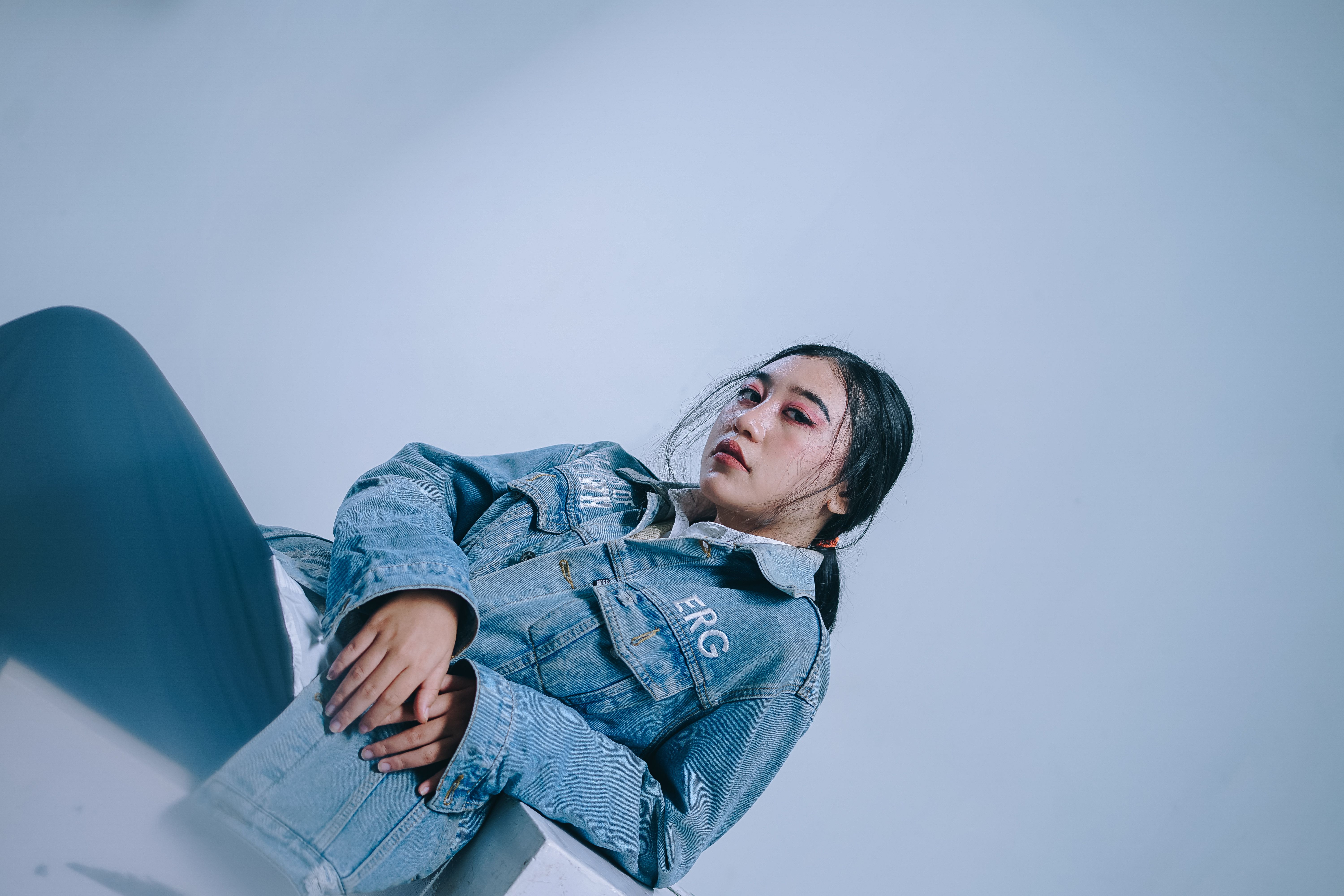 Woman Wearing a Denim Jacket with Hands on Head · Free Stock Photo