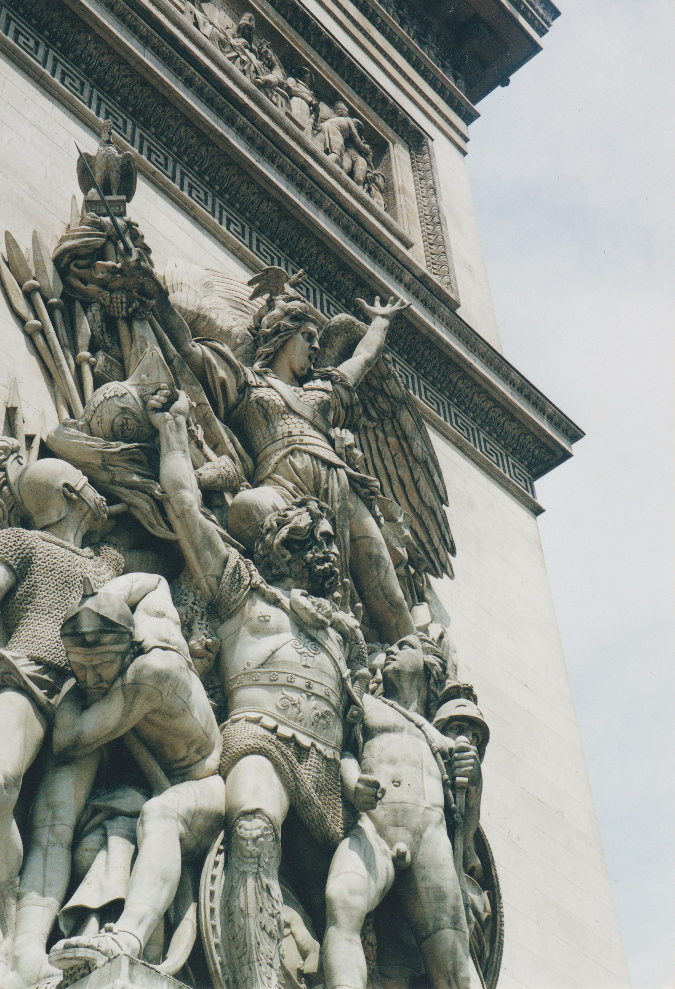 A sculpture of a group of men on top of a building · Free Stock Photo