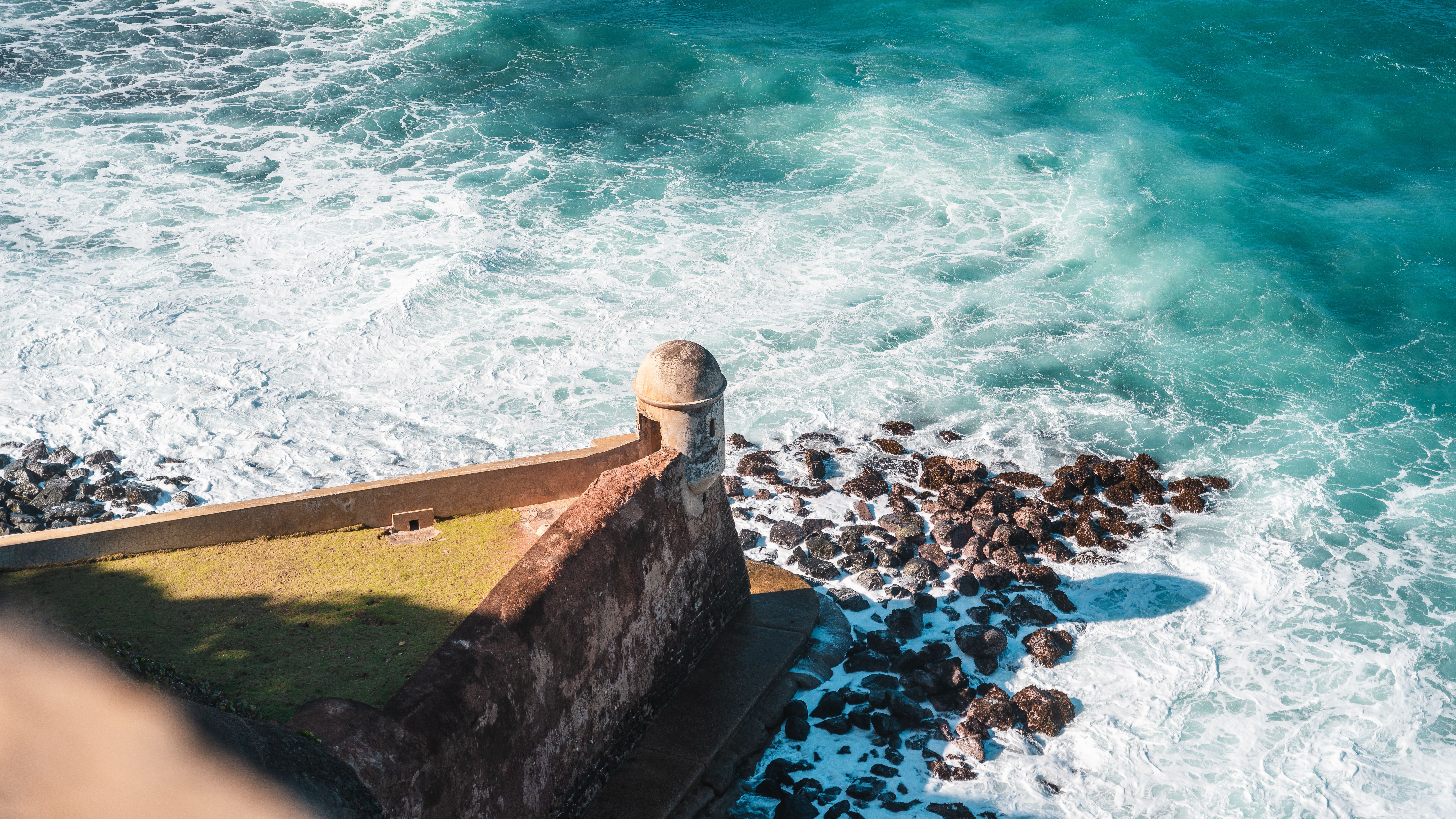 Waves Splashing on Shore with Stone Fort · Free Stock Photo