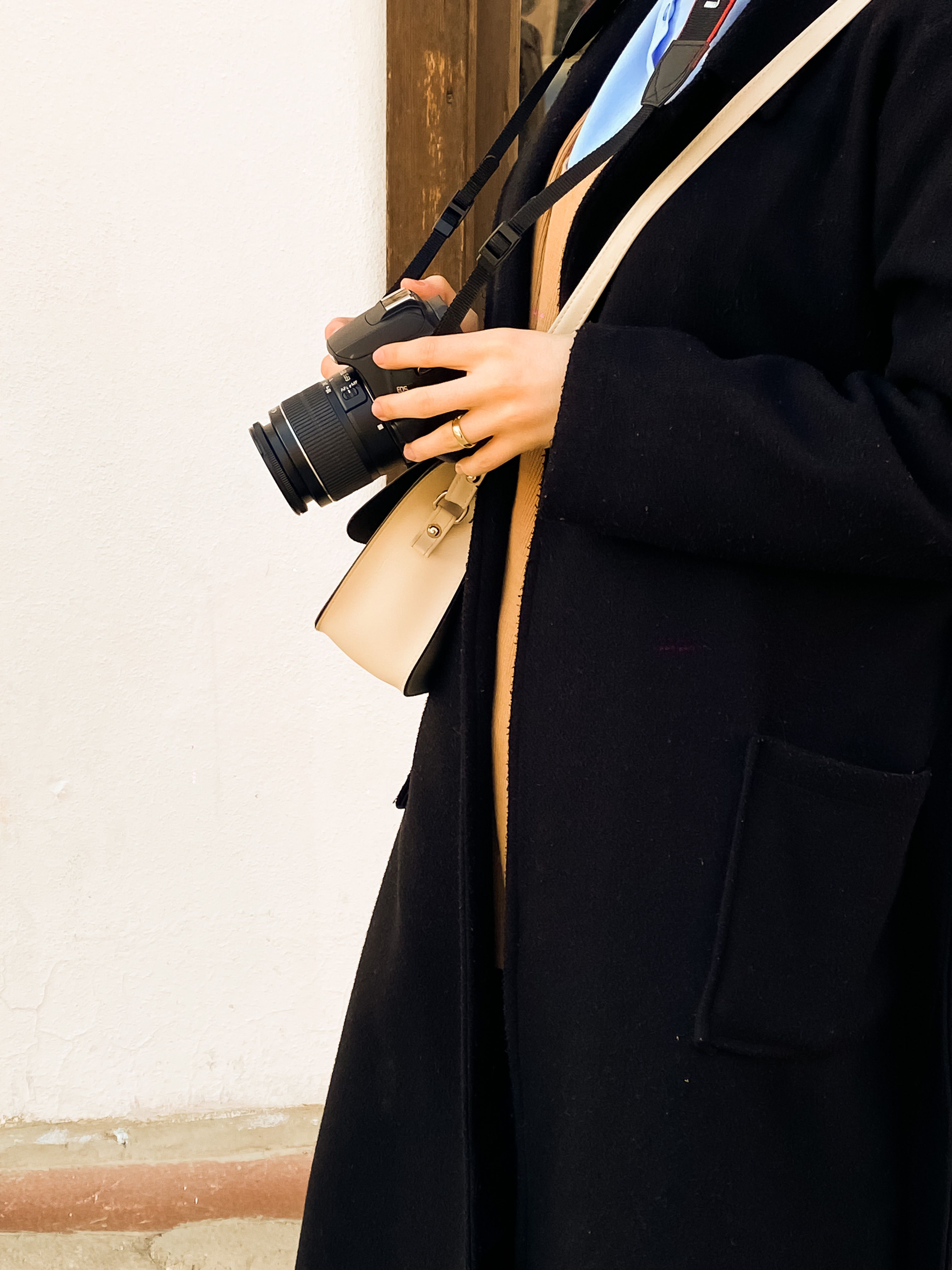 Woman in a Coat Holding a Camera · Free Stock Photo